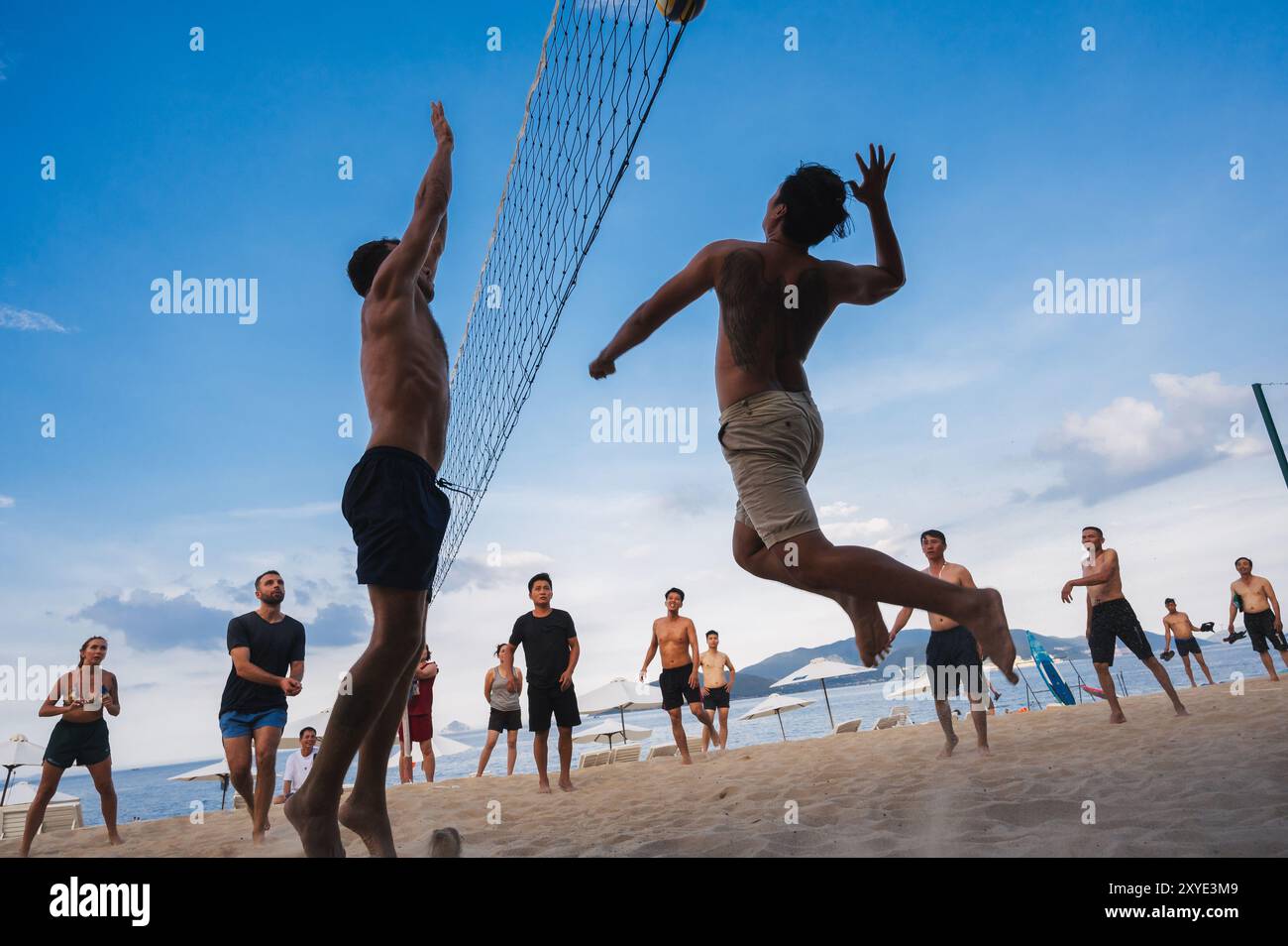 Multinational players play beach volleyball by the sea in Nha Trang in ...