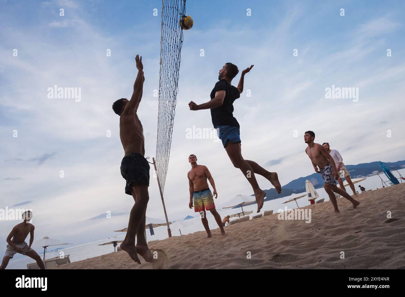 Teams with multinational players play beach volleyball on the beach by ...