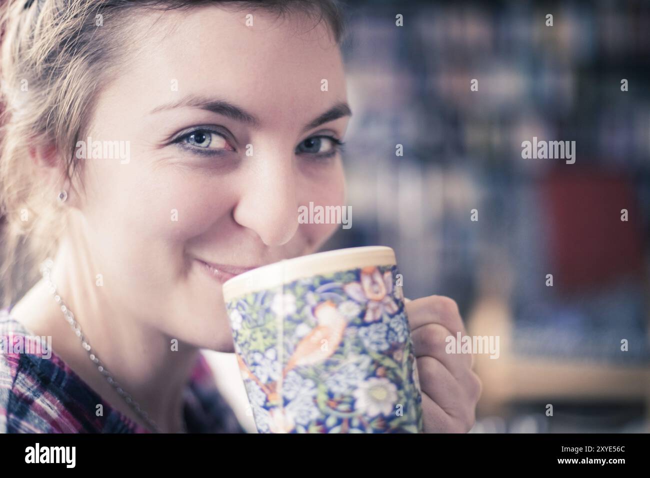 Beautiful young woman is enjoying a cup of tea Stock Photo - Alamy