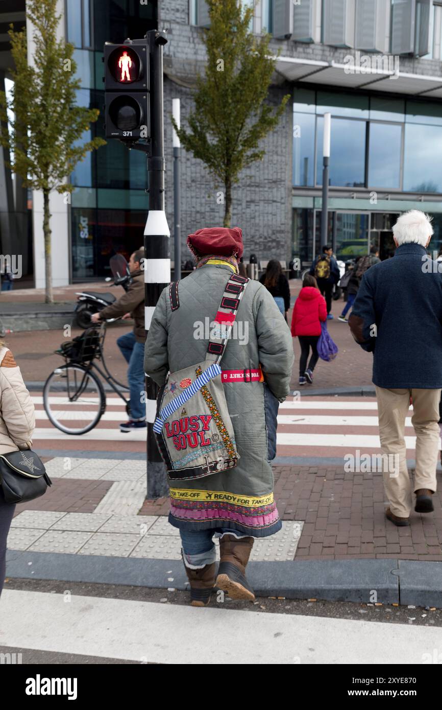 Pedestrians walk across a zebra crossing Stock Photo - Alamy