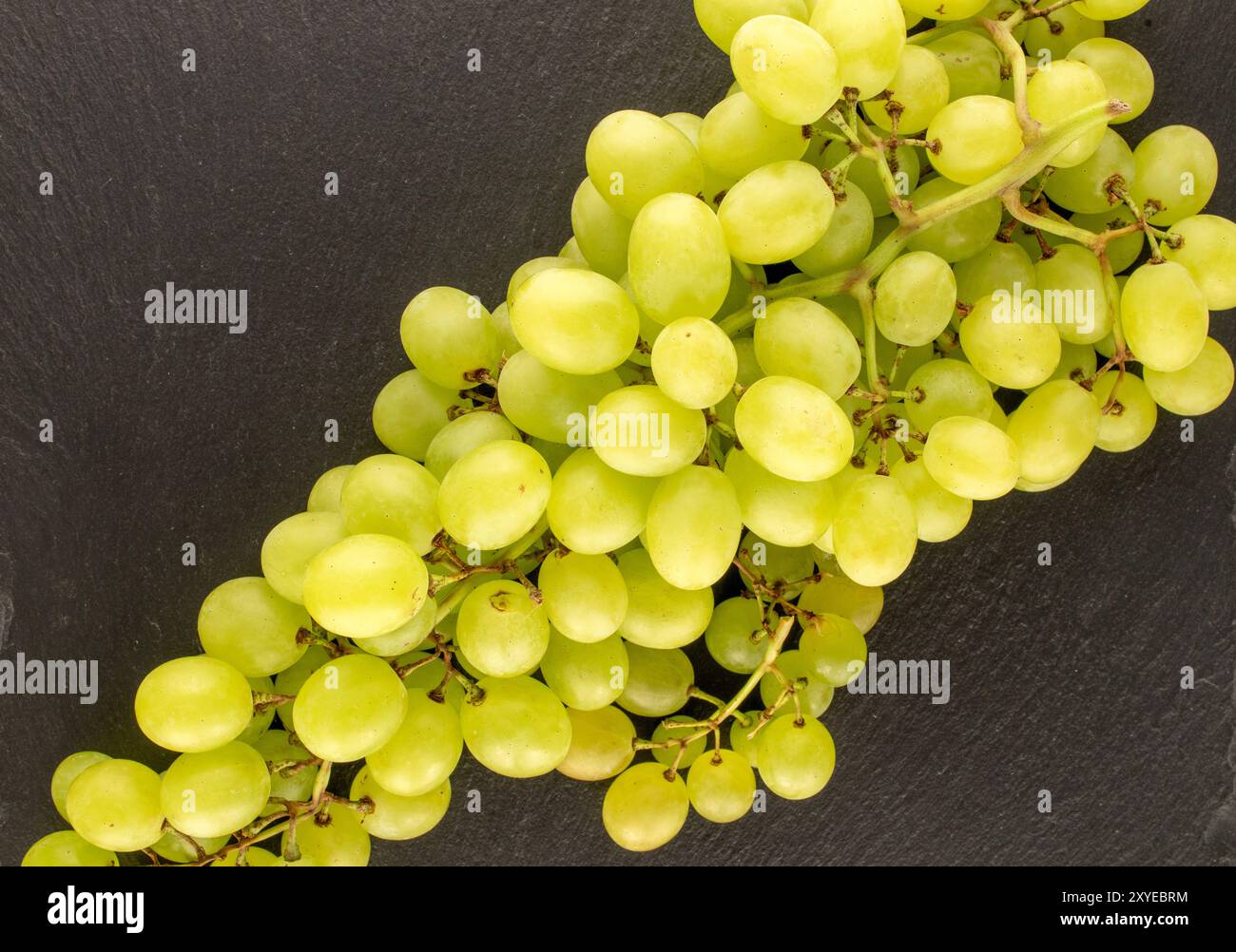 Bunch of ripe seedless grapes on slate stone, macro, top view Stock ...