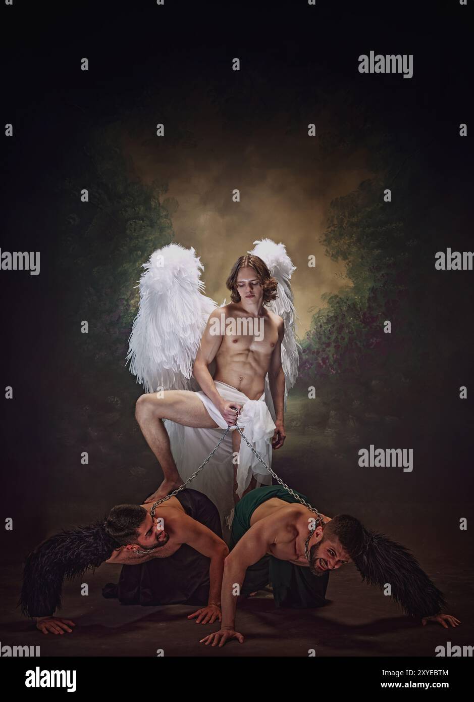 Angel powerfully holds chains of two subdued demons, symbolizing control and triumph of virtue ...