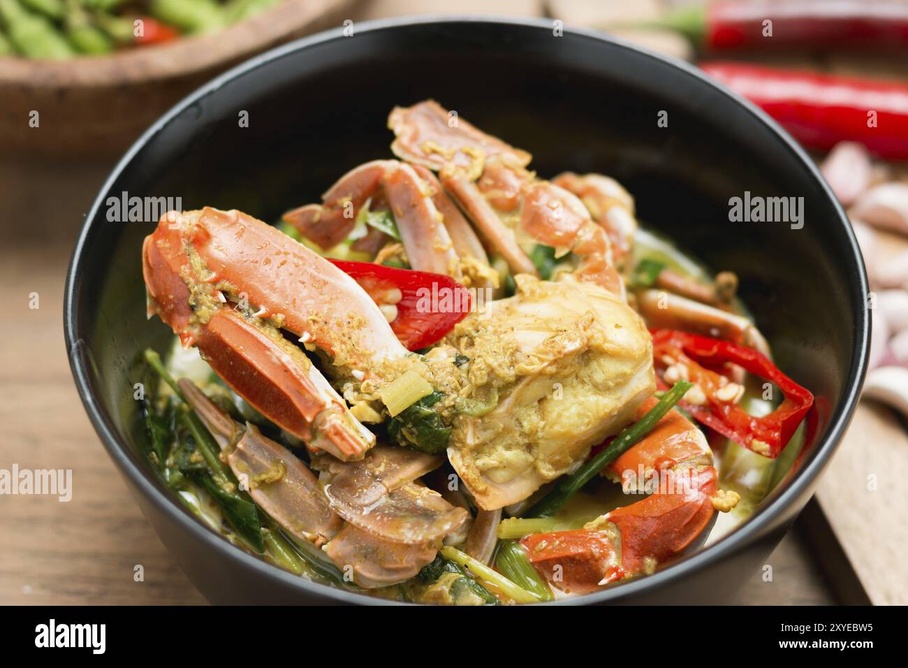 Delicious Thai Food Stir Fried crab in yellow curry on wooden Stock Photo - Alamy