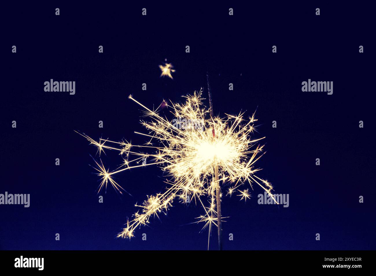 Christmas sparkler on black background. Sparks Stock Photo - Alamy
