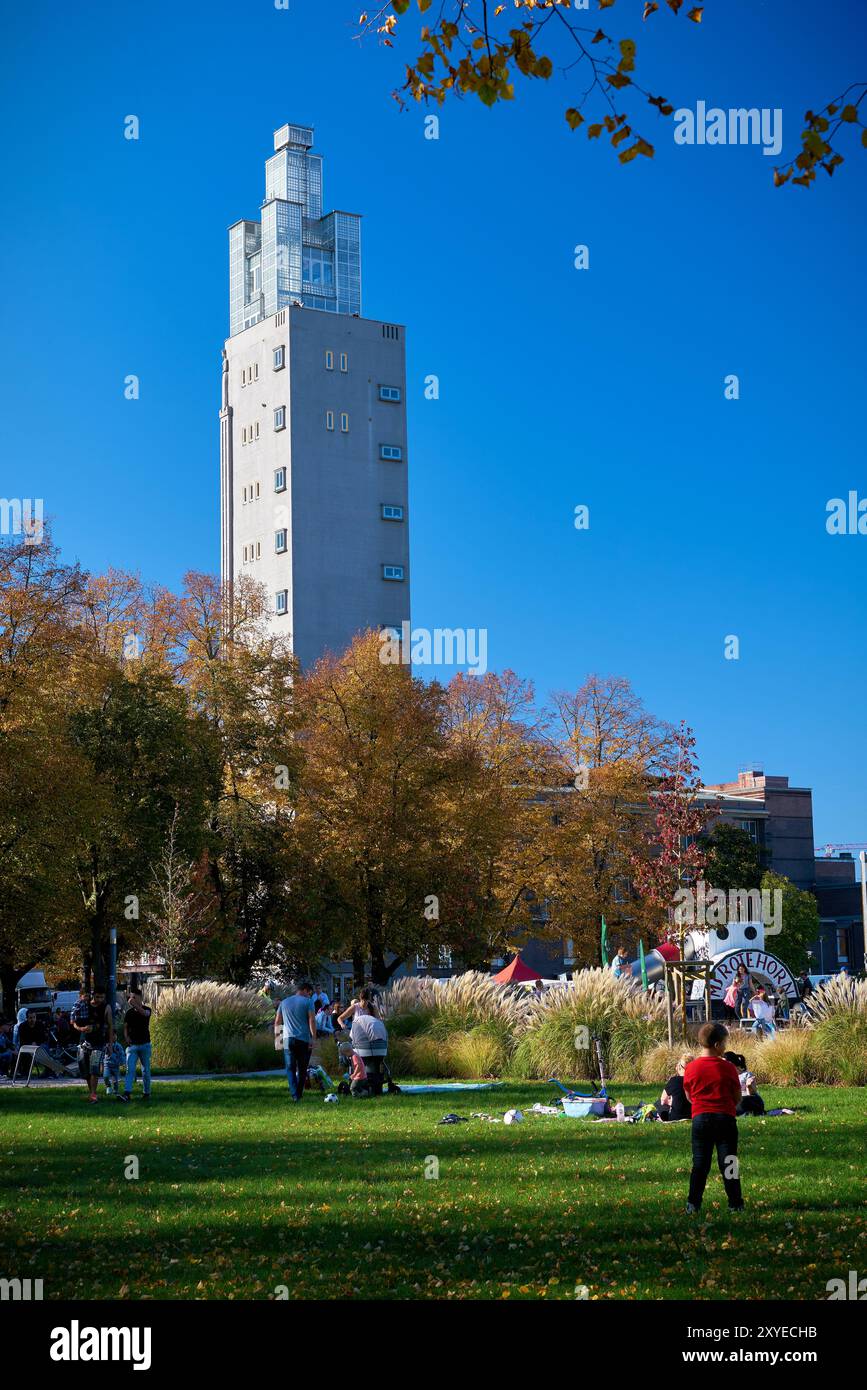 People in the municipal park of Magdeburg. In the background is the ...