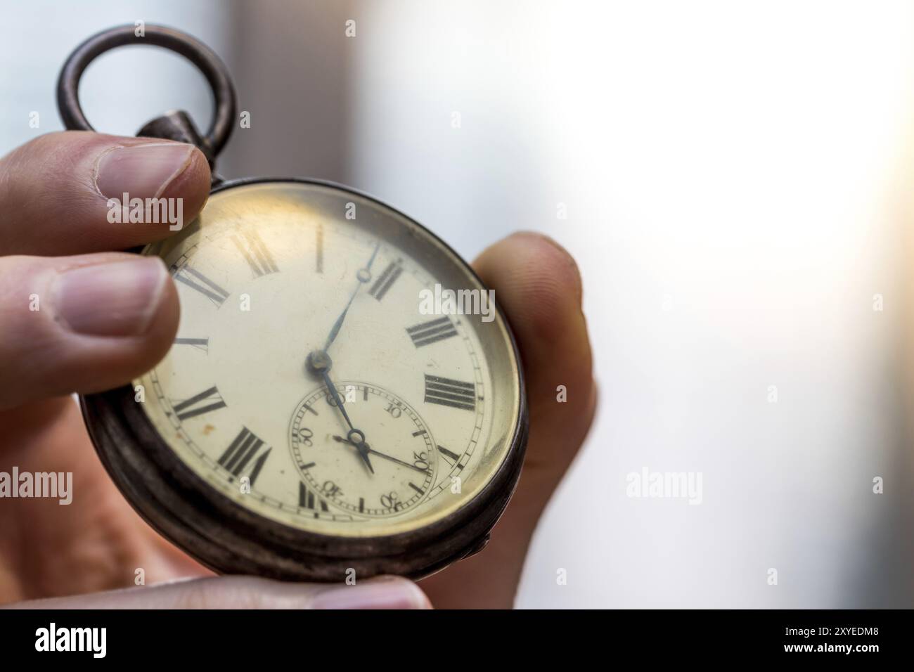 Time goes by: Man is holding a vintage watch in his hand, business ...