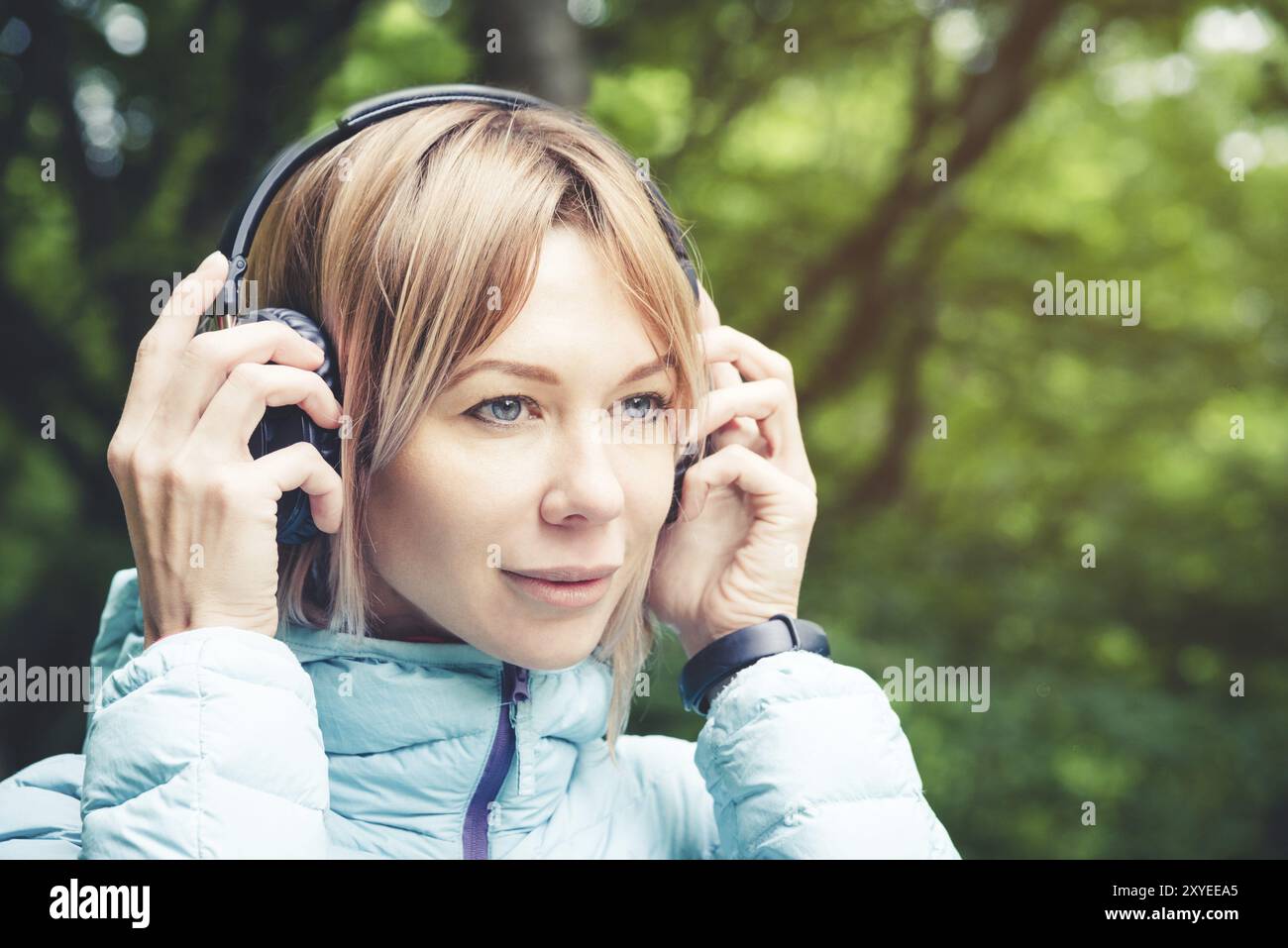 Portrait of an attractive sports girl blonde in a light running down ...
