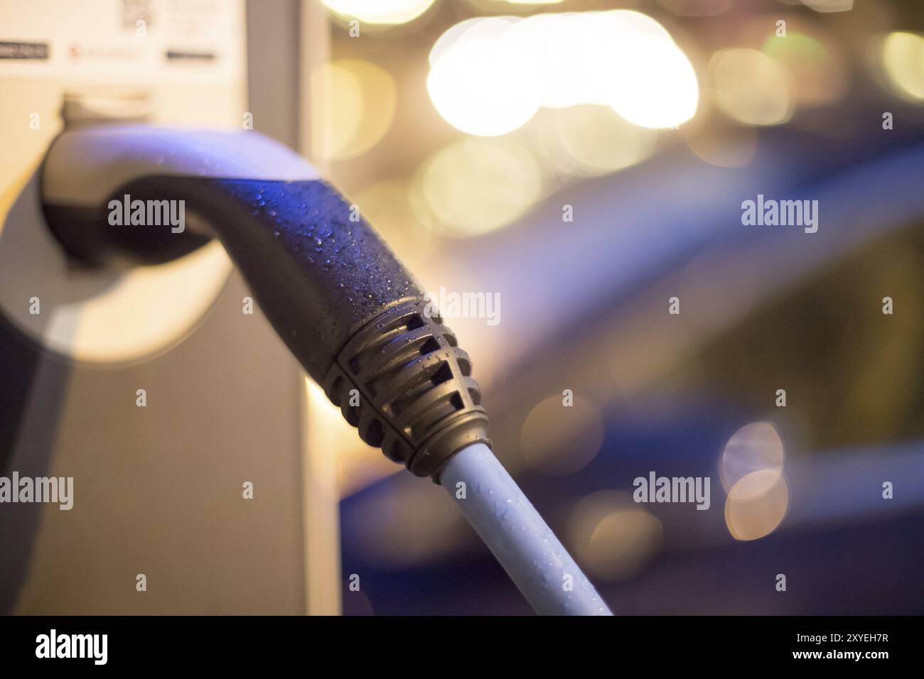 Electric car recharging with charge cable and plug leading to charge ...