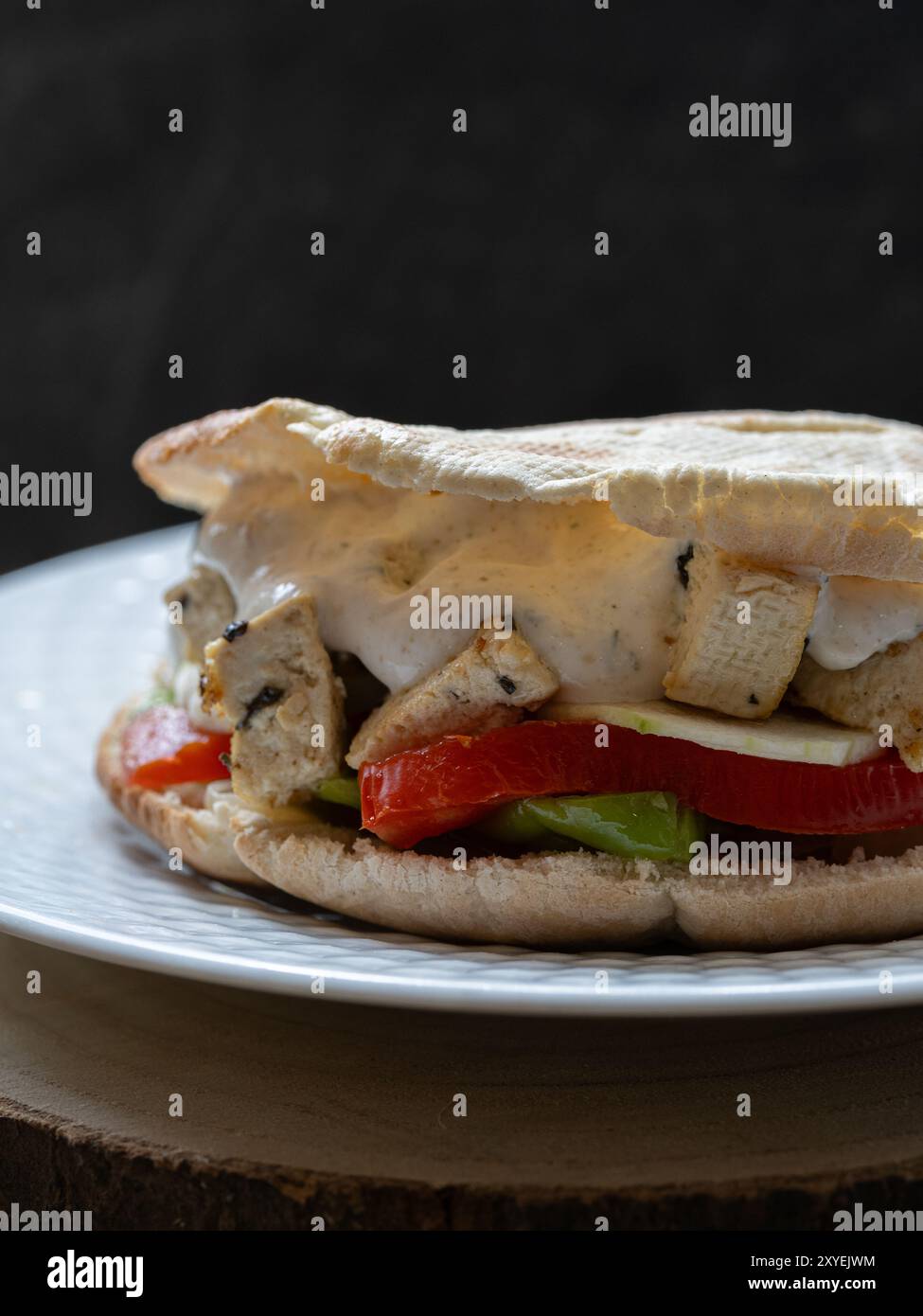 Vertical photo of vegetarian sandwich with grilled vegetables, tofu and ...