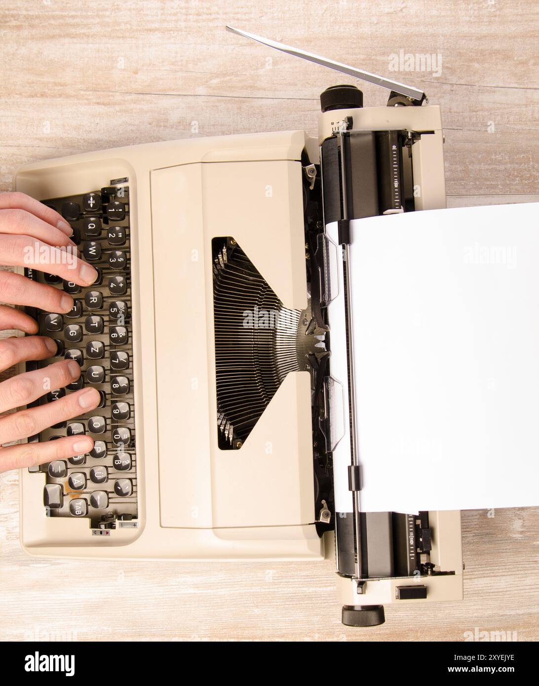 Man writing a letter on a vintage typewriter. top view Stock Photo - Alamy