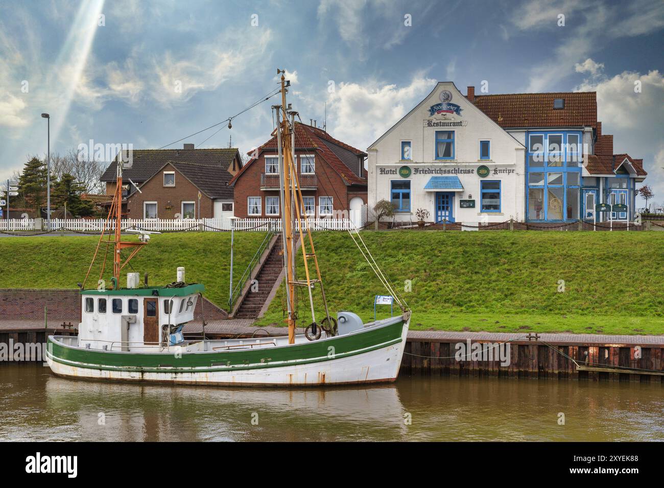Fishing boat docks at a pub Stock Photo - Alamy