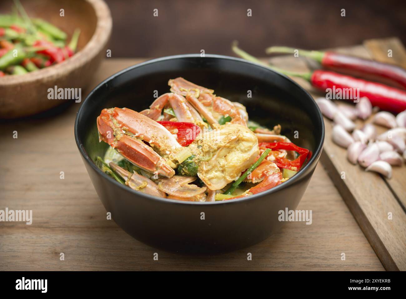Delicious Thai Food Stir Fried crab in yellow curry on wooden Stock Photo - Alamy
