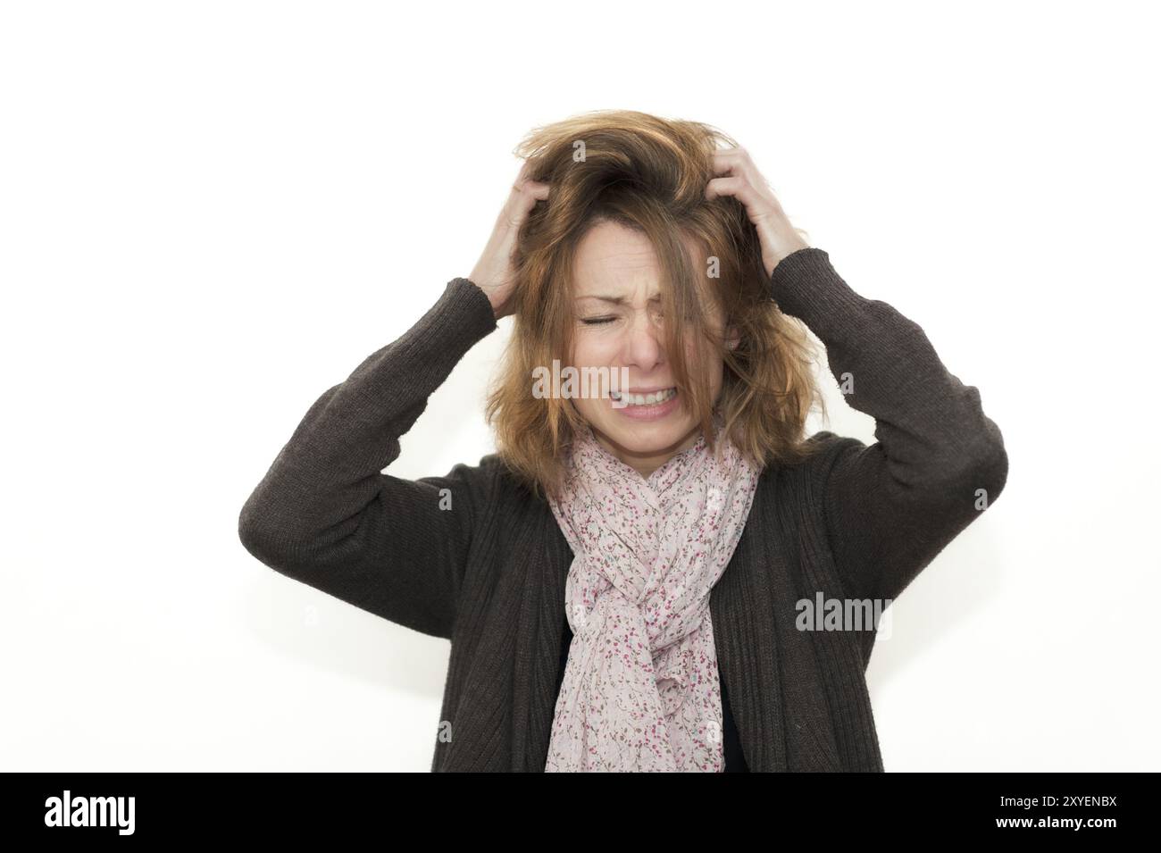 Young woman frantically ruffles her hair Stock Photo - Alamy