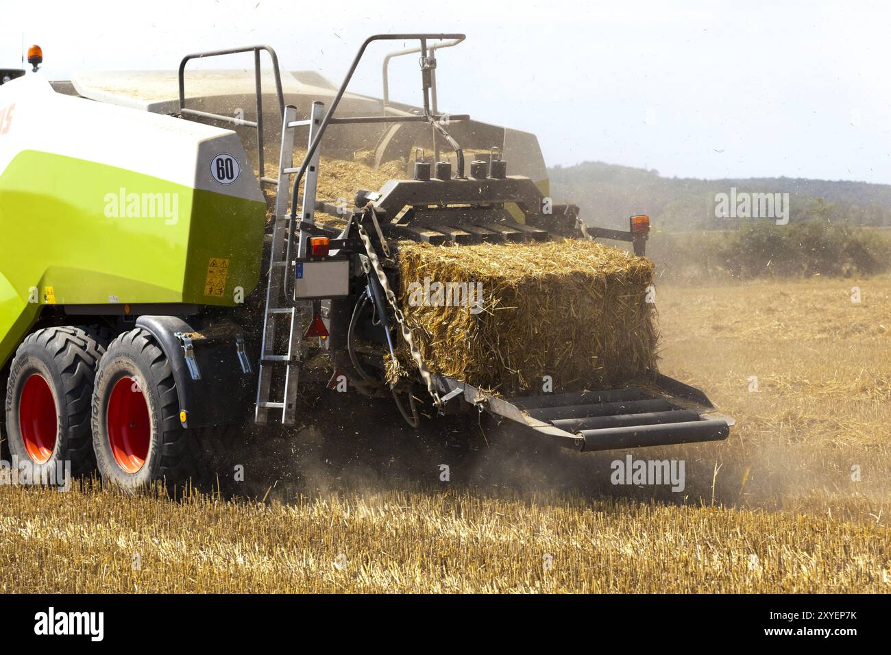 Tractor with a straw baler Stock Photo - Alamy