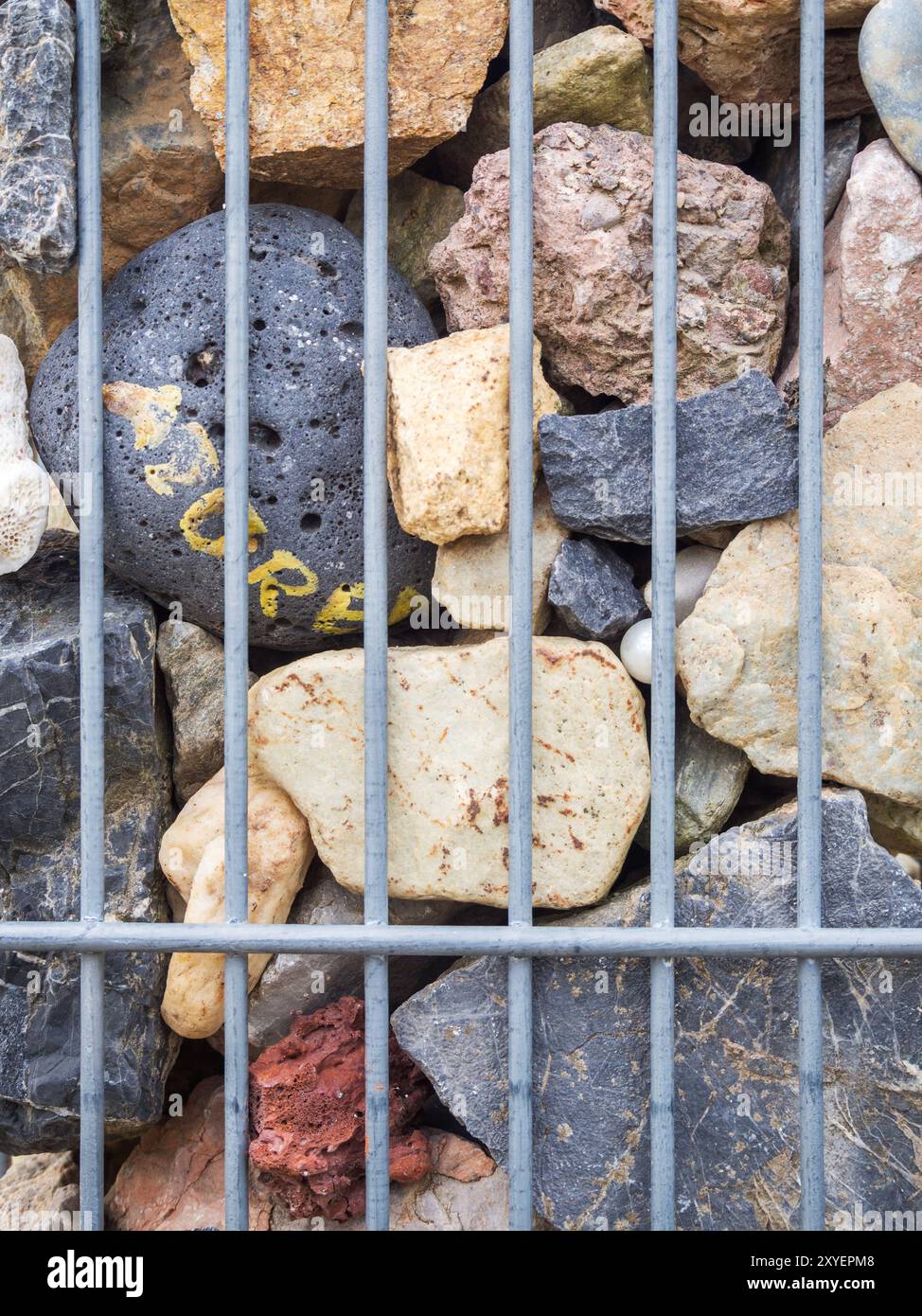 Stones in a mesh basket Stock Photo - Alamy