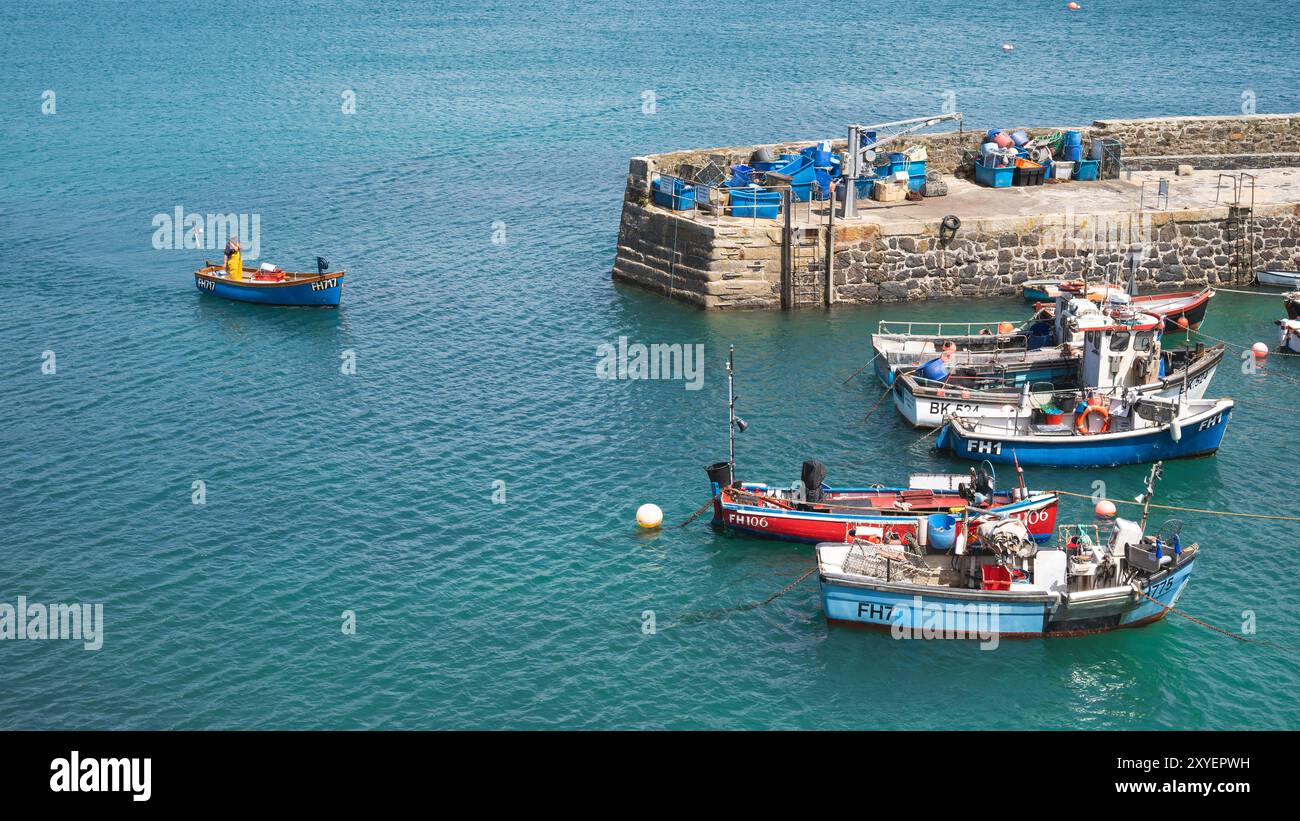 COVERACK, CORNWALL, UK - JUNE 15, 2024. A local Cornish fisherman in a ...