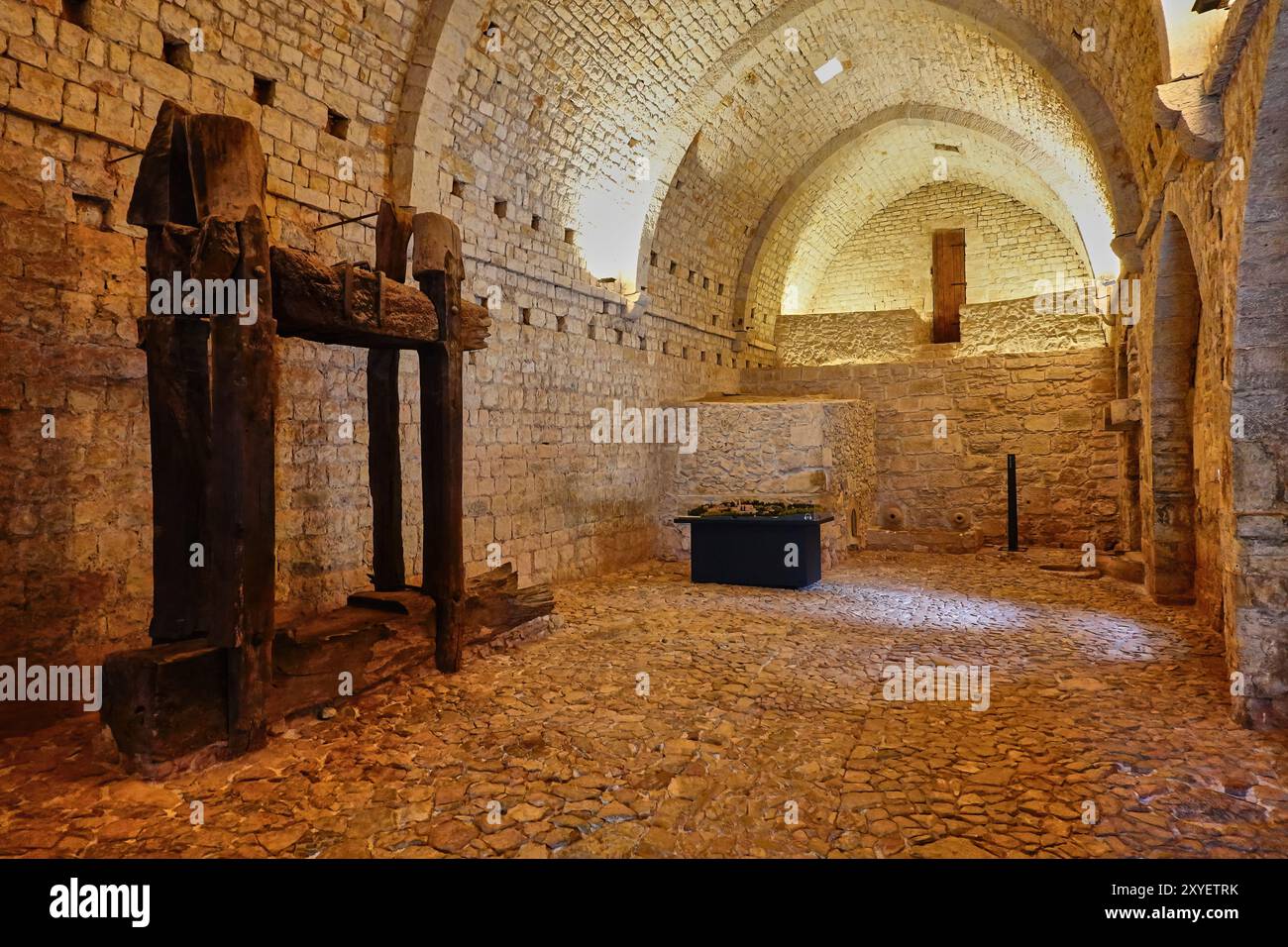 Historic Stone Chamber Featuring Ancient Wooden Press and Rustic ...