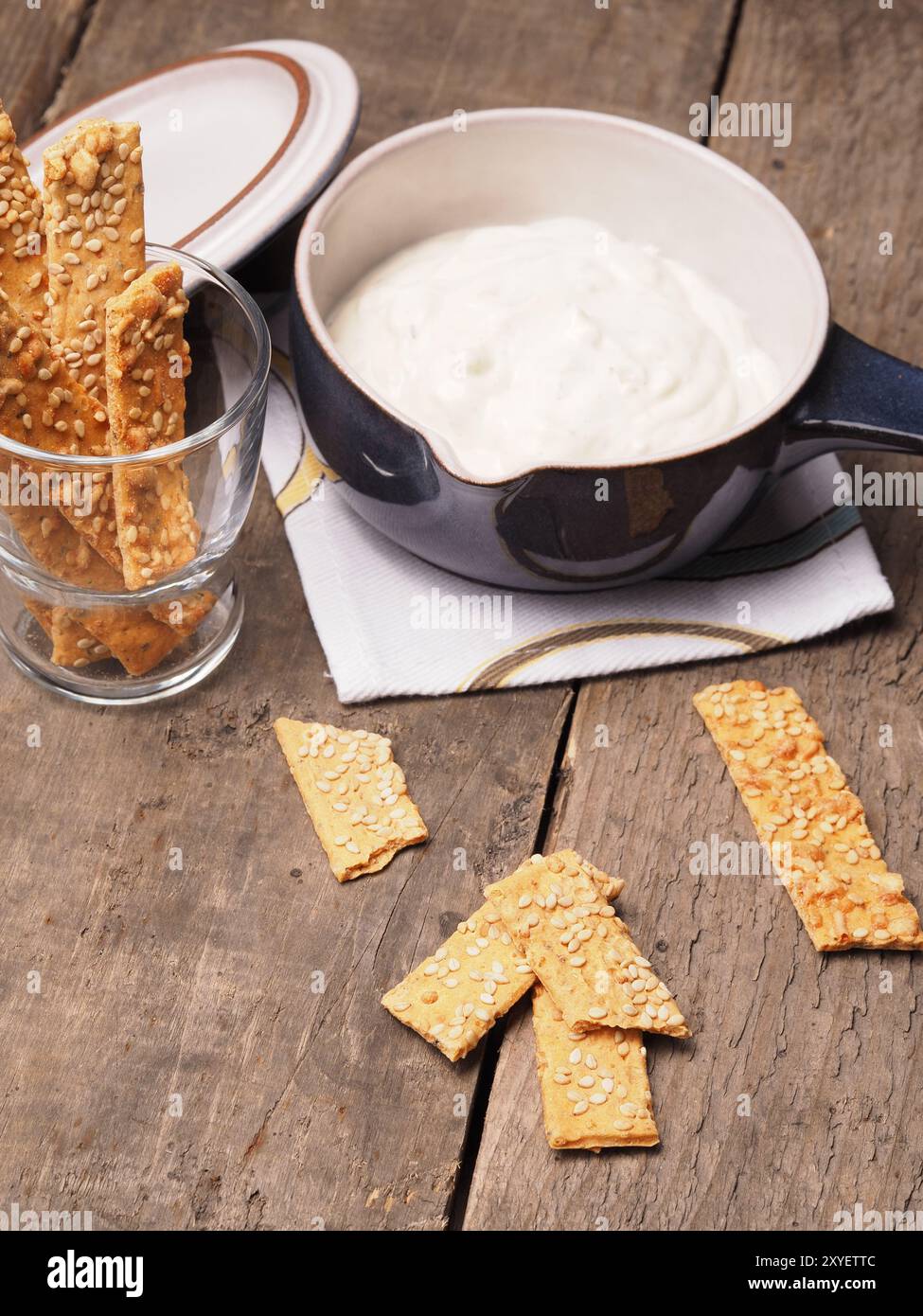 Organic cracker with sesame on a rustic wooden table Stock Photo - Alamy