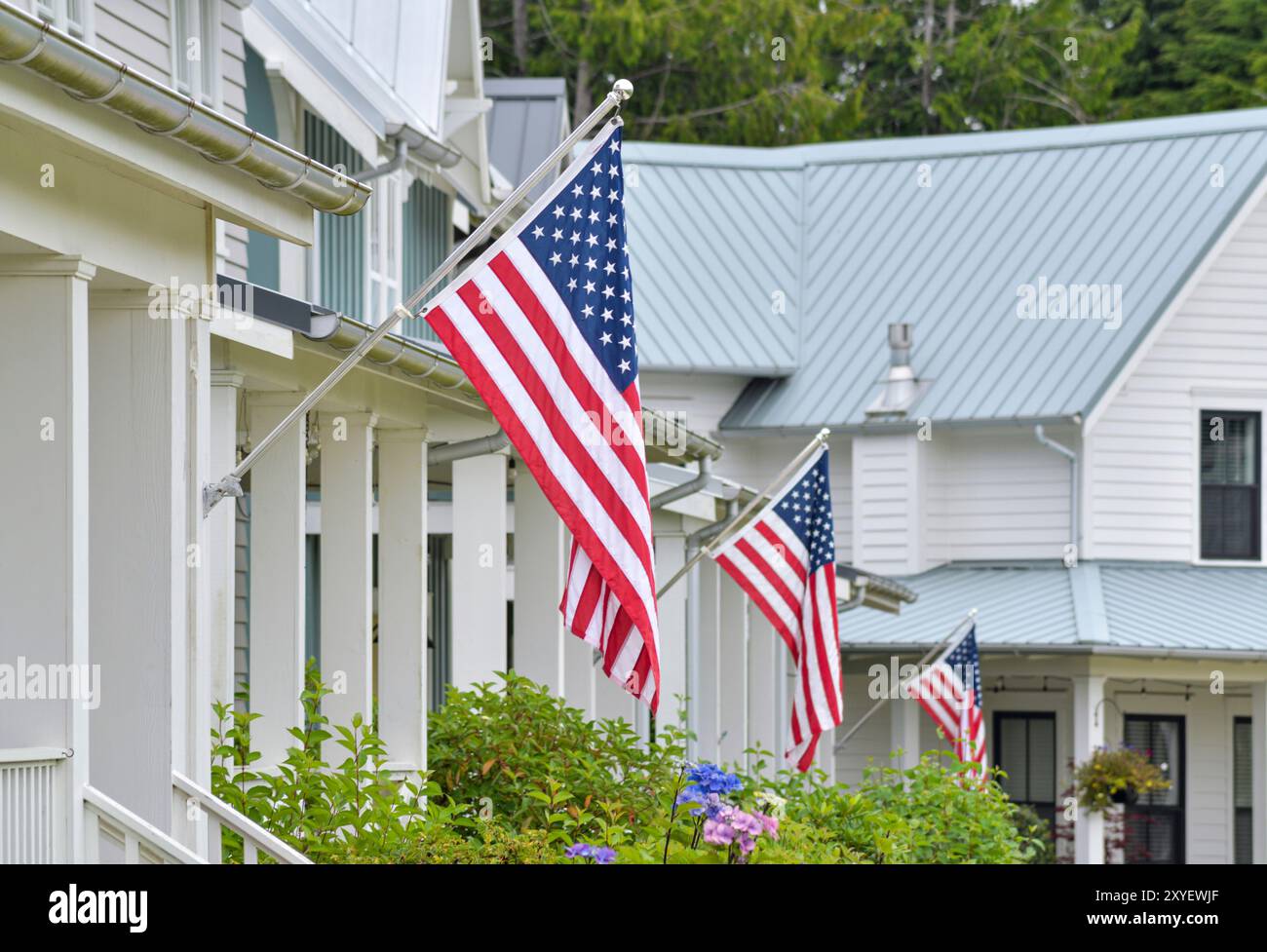 American flags hanging from homes in a neigborhood Stock Photo - Alamy