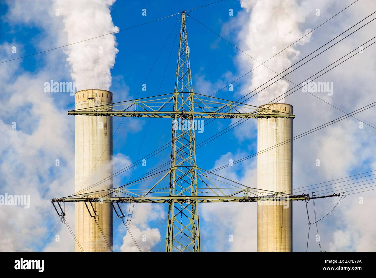 2 power station chimneys with electricity pylon Stock Photo - Alamy