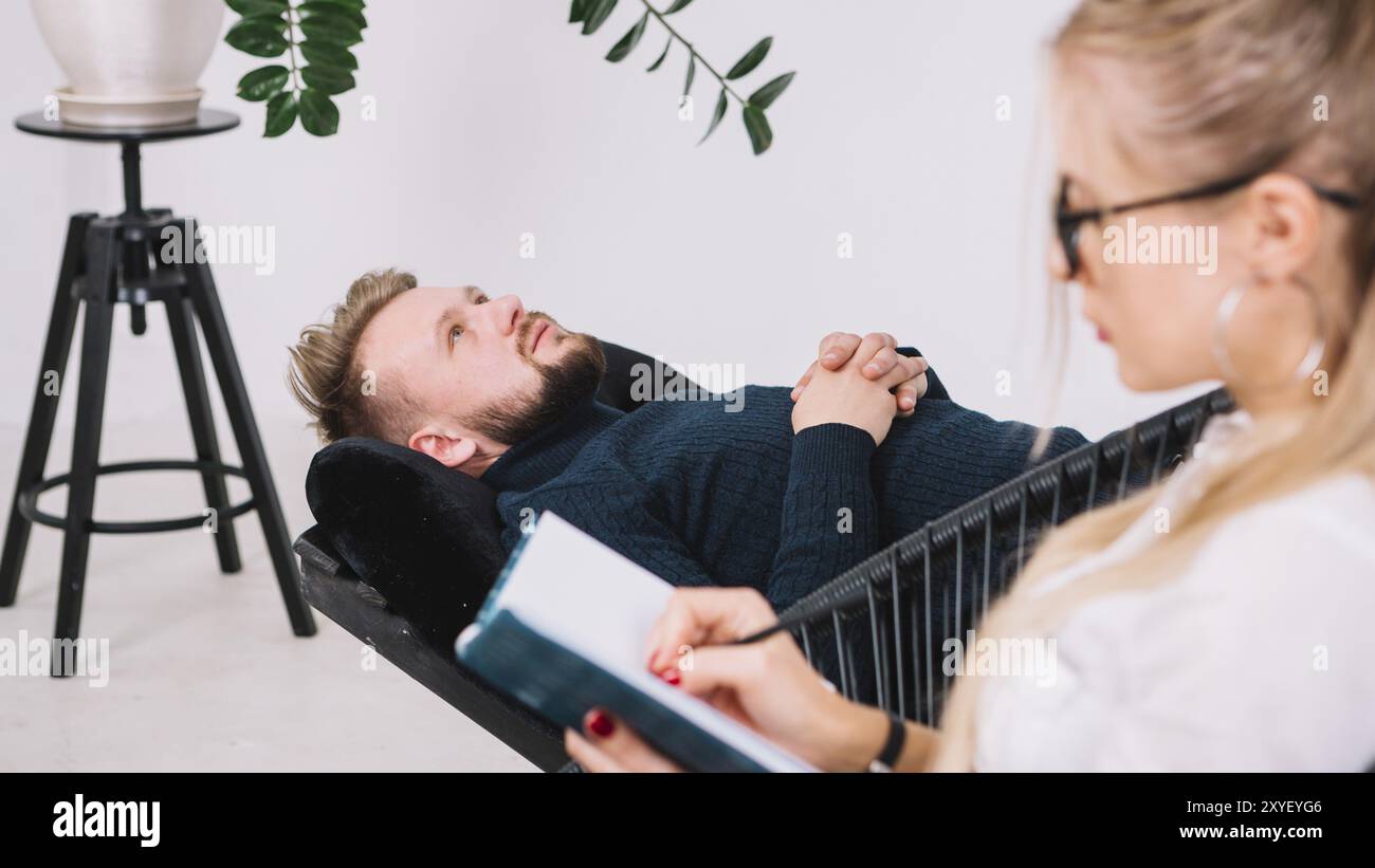 Close up female psychologist writing down notes during therapy with her ...