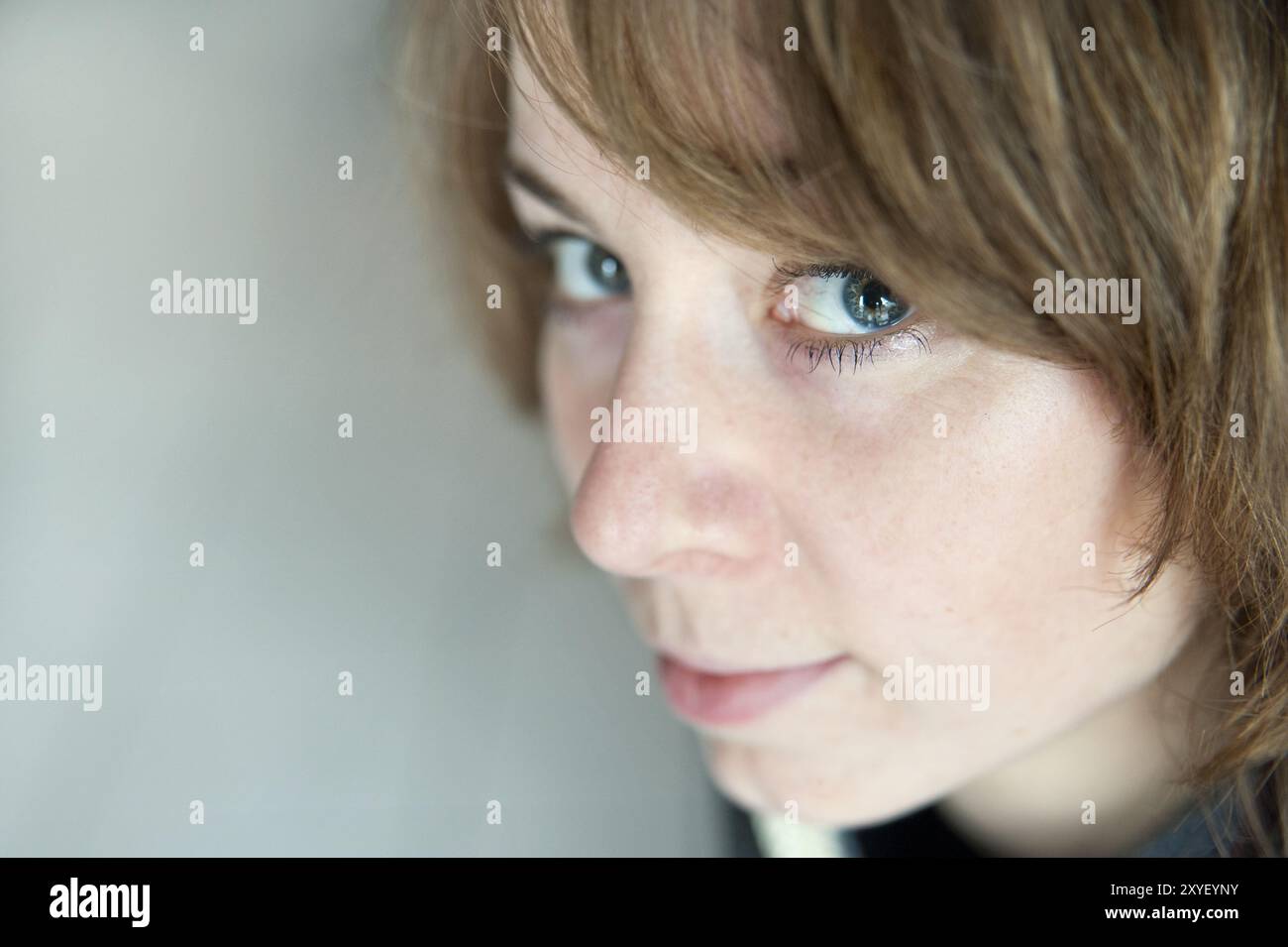 Young woman with scrutinising gaze from below Stock Photo - Alamy