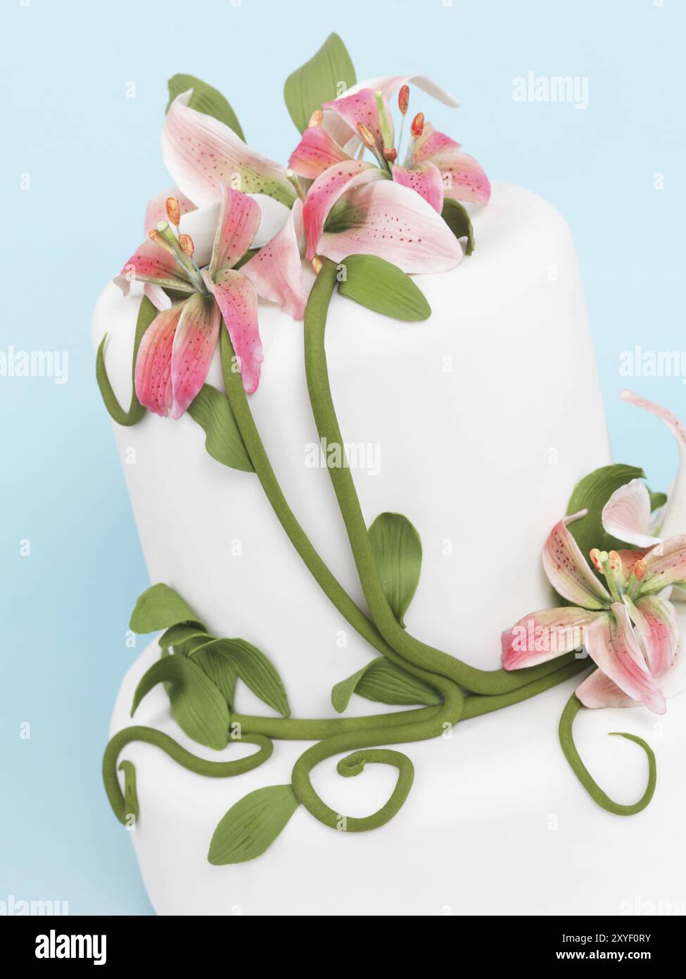 Fancy cake decorated with lilies isolated on blue background Stock ...