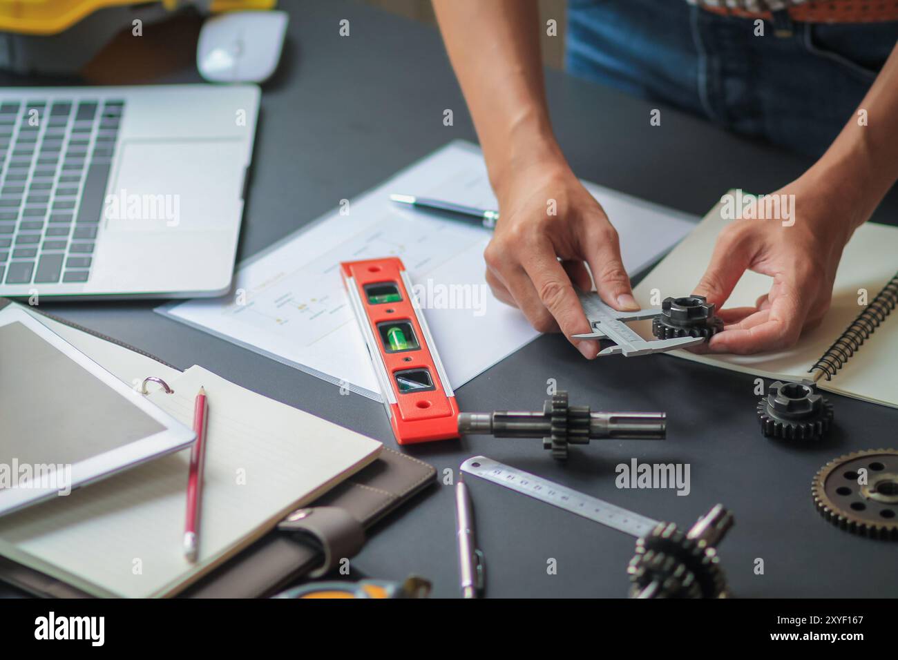 The gear set is placed on the workbench of a team of factory mechanical engineers to study and ...