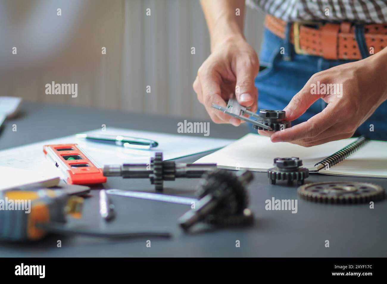 The gear set is placed on the workbench of a team of factory mechanical ...