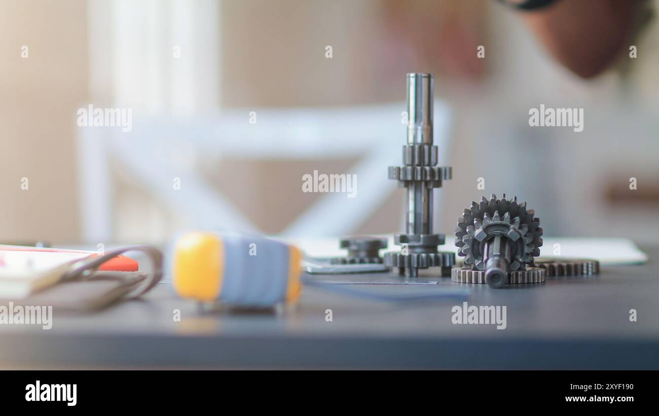 The gear set is placed on the workbench of a team of factory mechanical engineers to study and ...