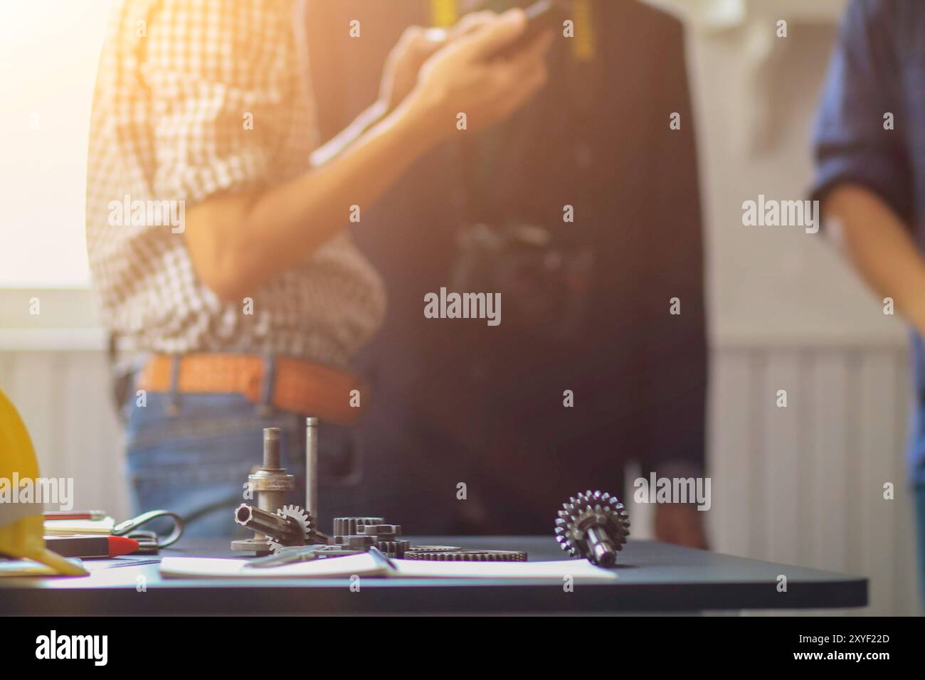 The gear set is placed on the workbench of a team of factory mechanical ...