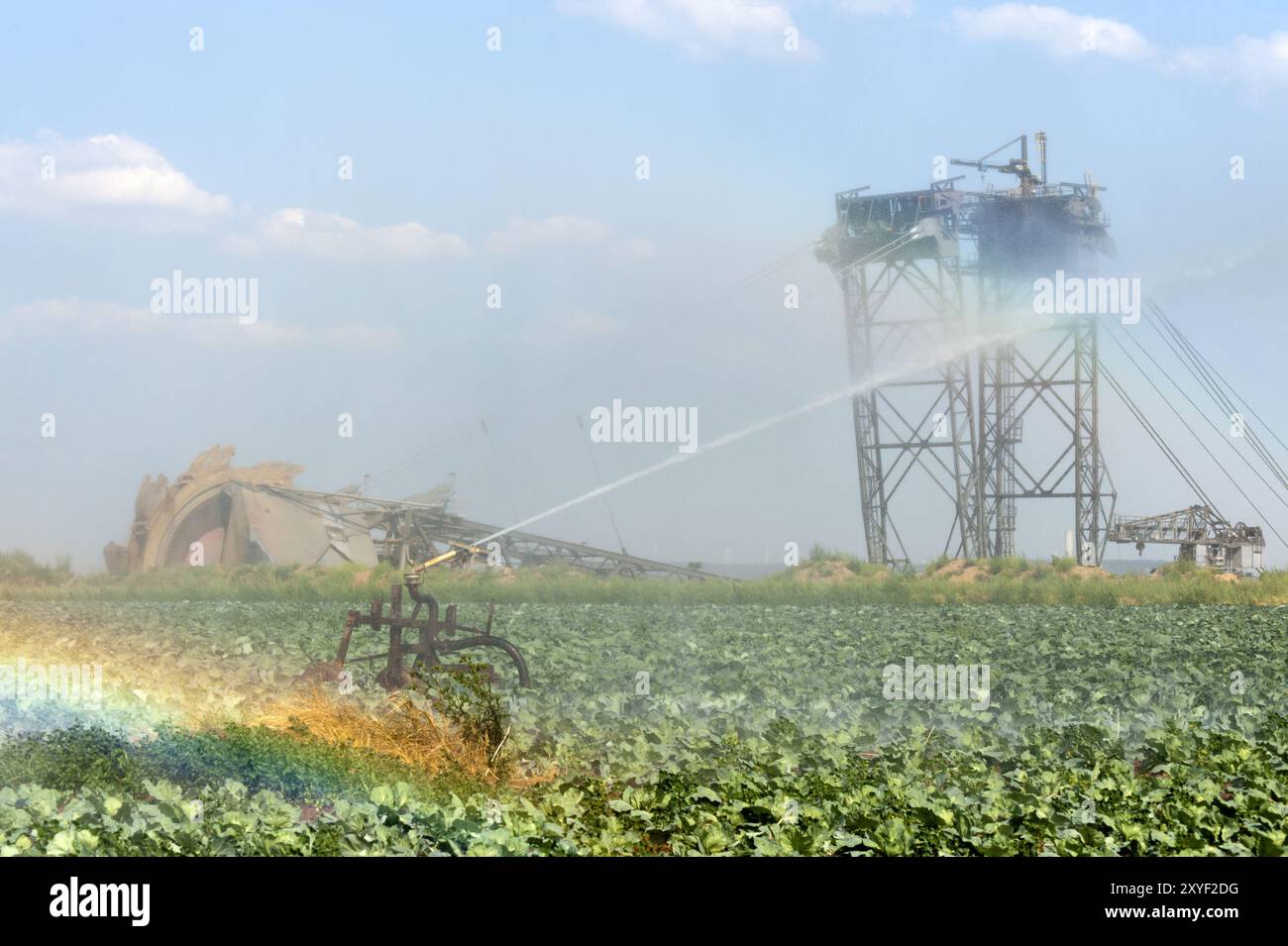 Agriculture sprinkler system in front of a bucket wheel excavator Stock ...