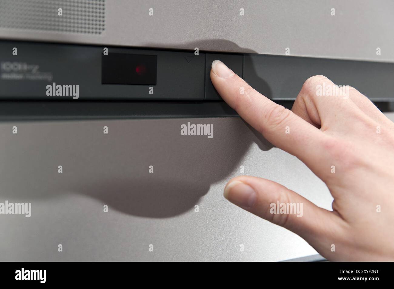 Hand with outstretched index finger switches off electrical device ...