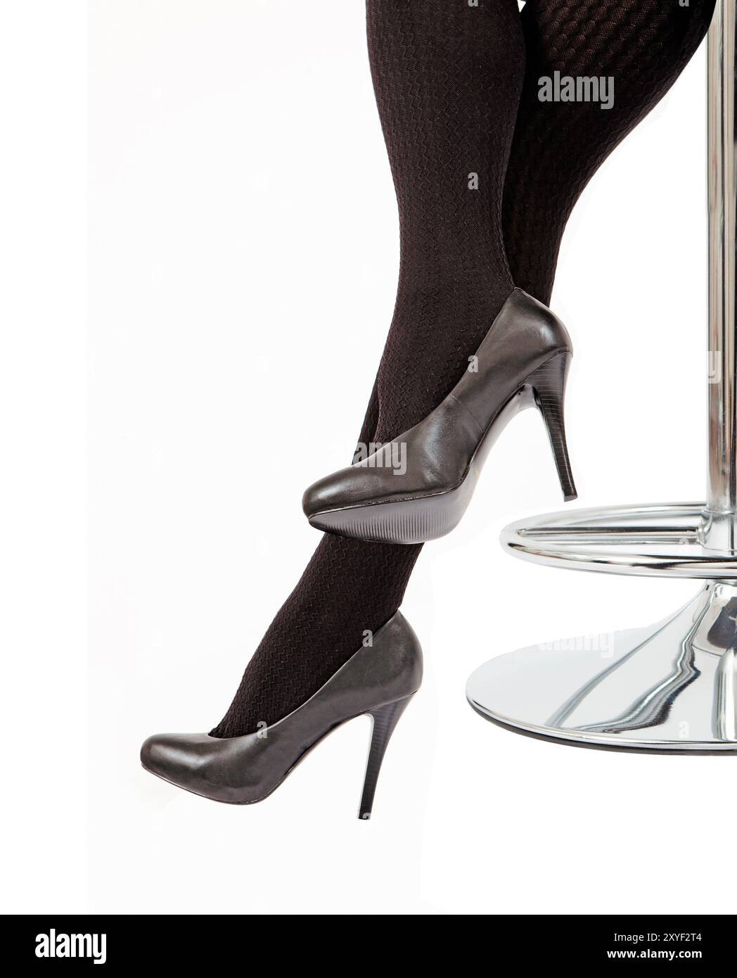 Woman sitting on a bar stool Stock Photo - Alamy