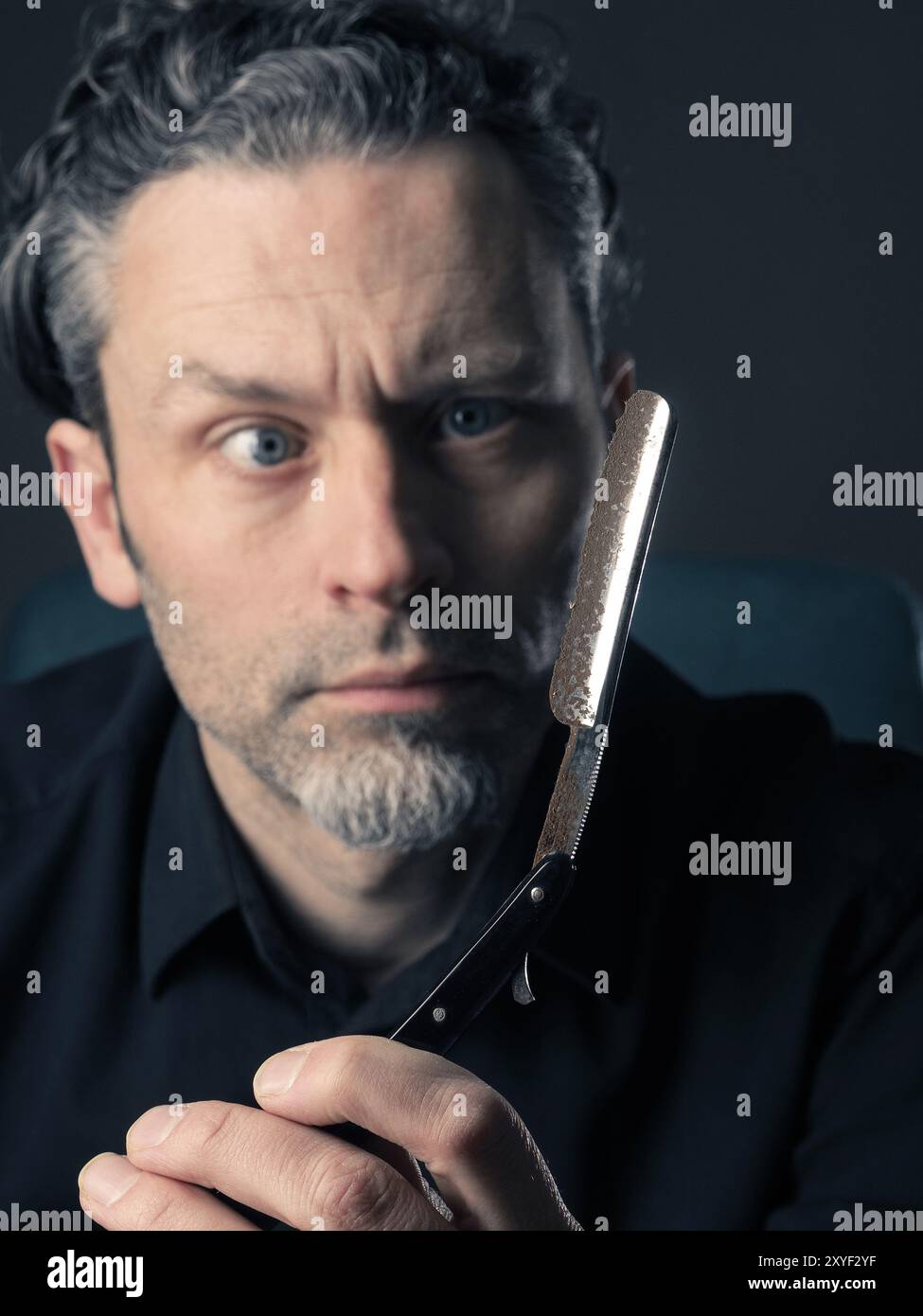 Handsome man with a rusty old shaving knife looking scary Stock Photo ...