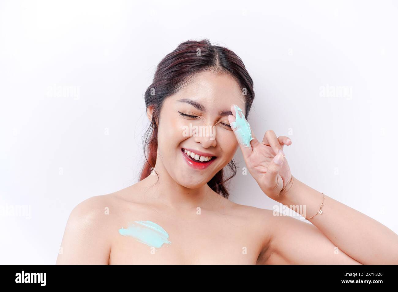 Skin Care Products Concept. Asian woman applying moisturizing lotion on ...