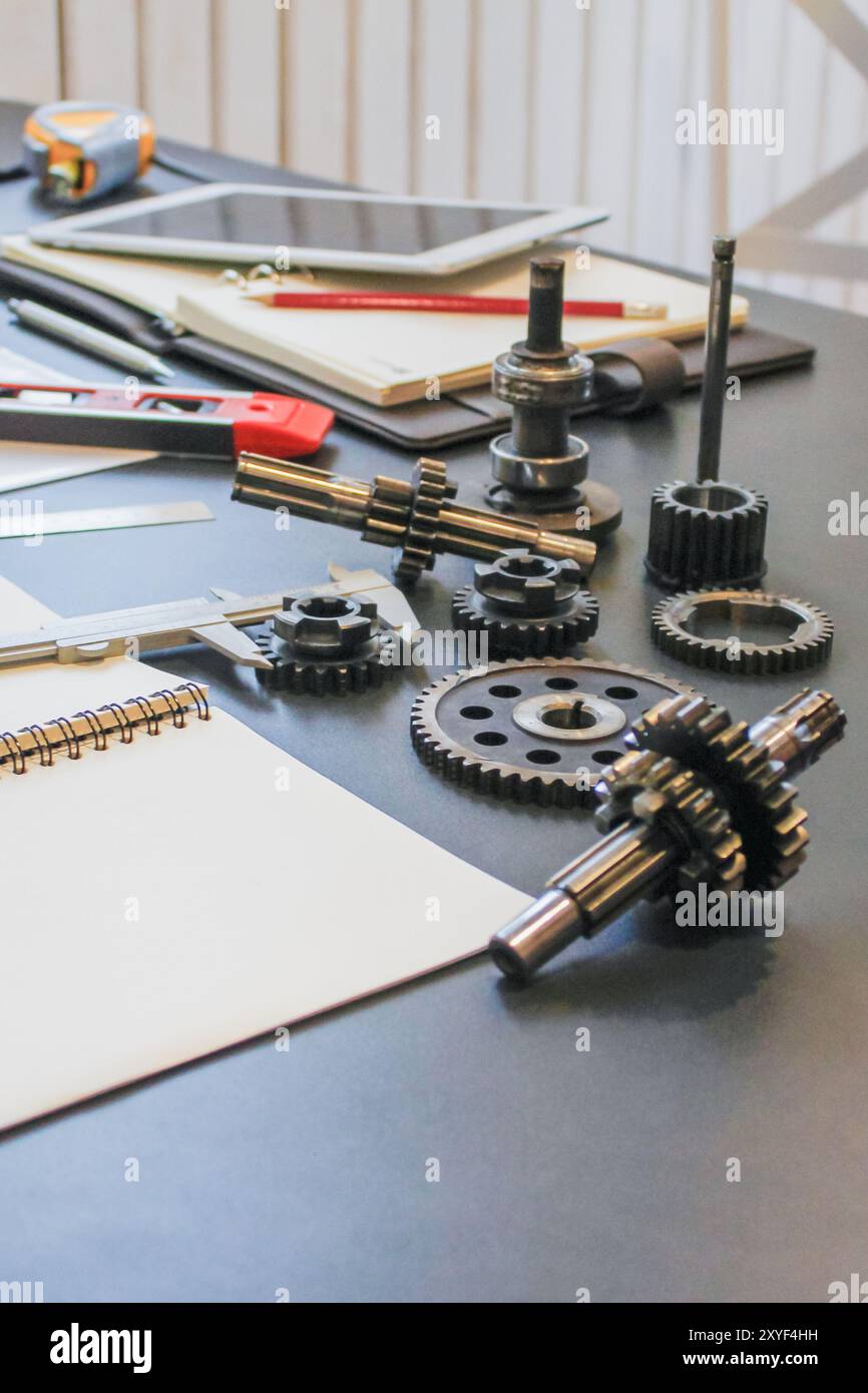 The gear set is placed on the workbench of a team of factory mechanical engineers to study and ...