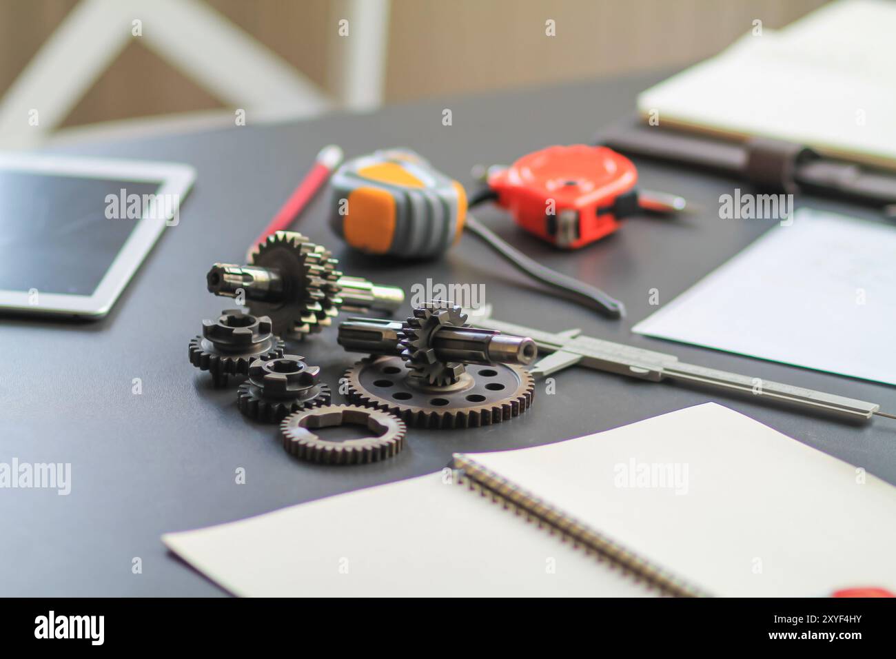 The gear set is placed on the workbench of a team of factory mechanical engineers to study and ...