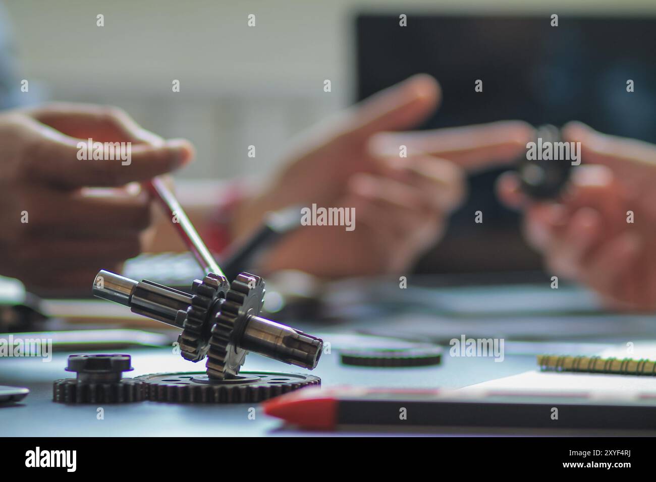 The gear set is placed on the workbench of a team of factory mechanical ...