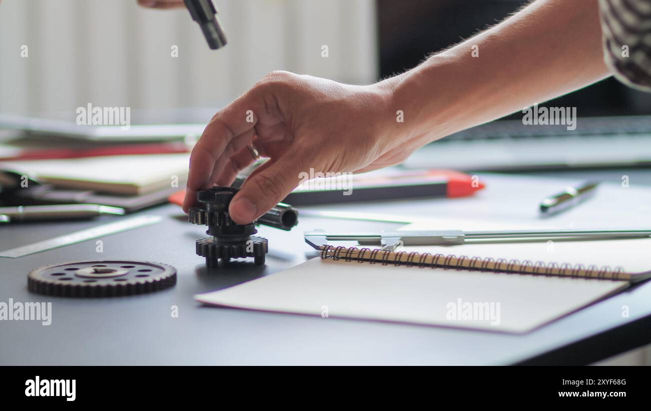 The gear set is placed on the workbench of a team of factory mechanical ...