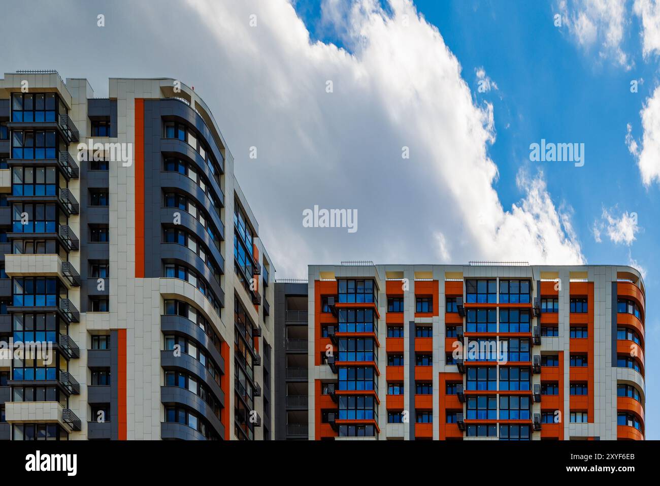 freshly built high rise apartment building on blue sky background with ...