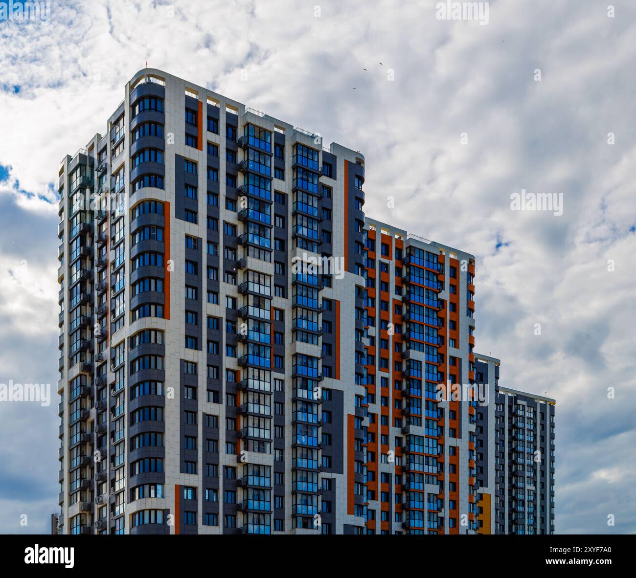 freshly built high rise apartment building on blue sky background with ...