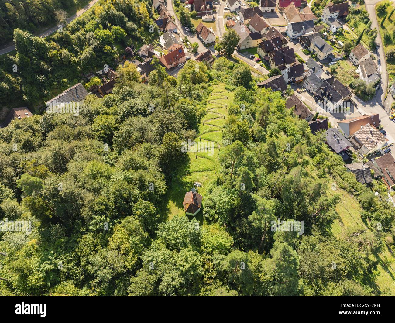 Aerial view of a peaceful cemetery in the forest near a small village ...