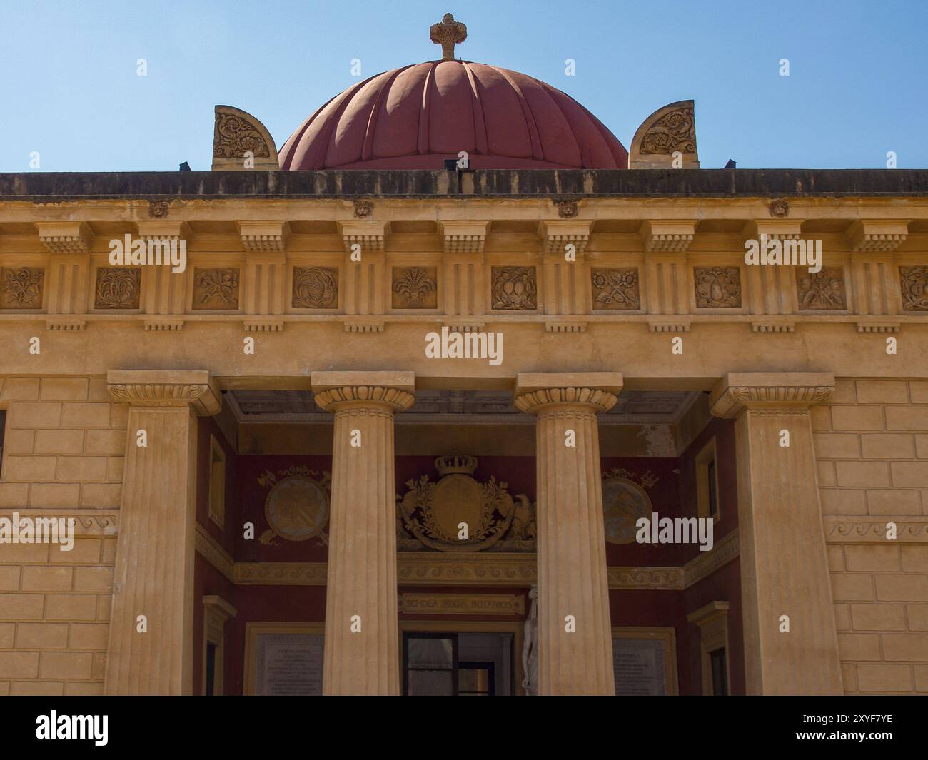 Historic building with columns and red dome, decorated with religious ...