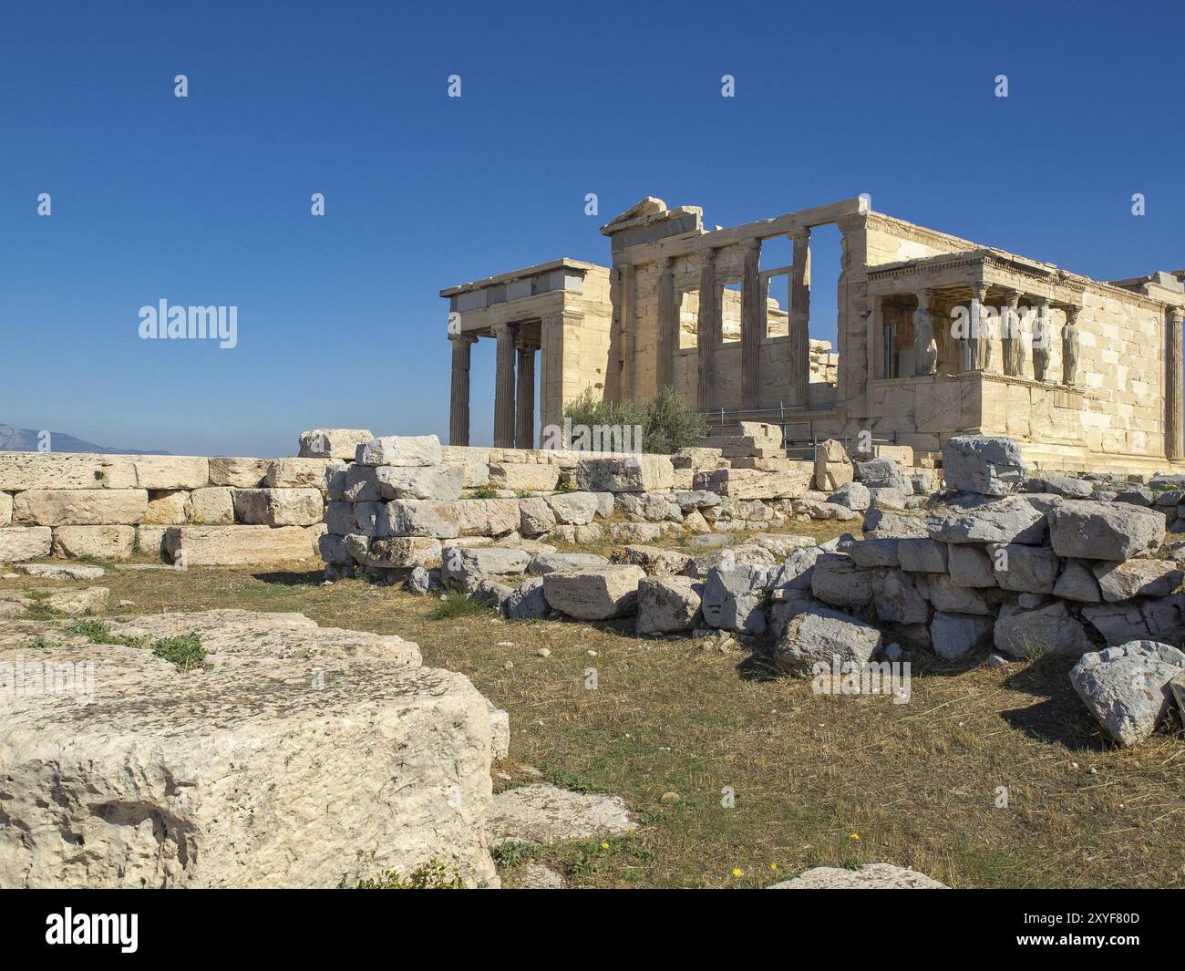 Ruins of an ancient temple with columns and stone blocks in front of a ...