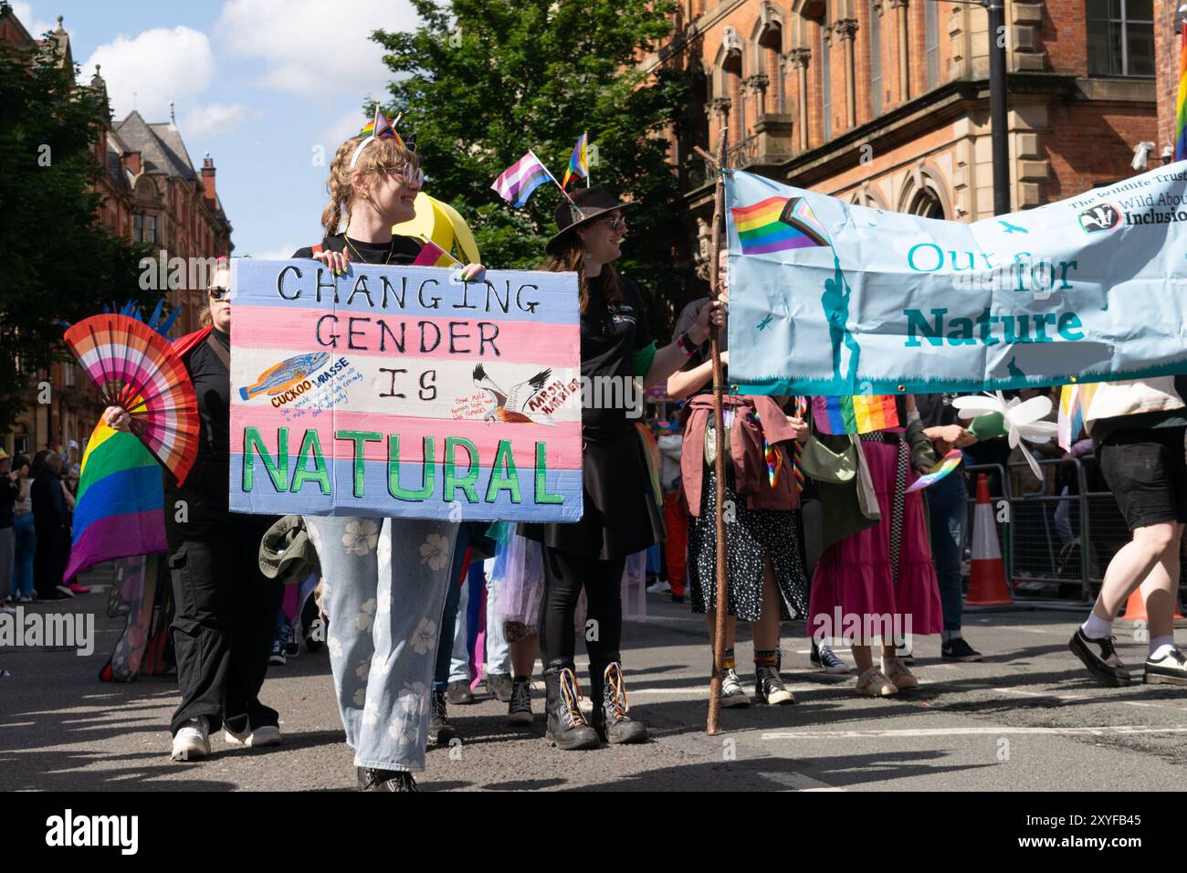 Pride parade, Manchester. Protester with banner Changing Gender is ...