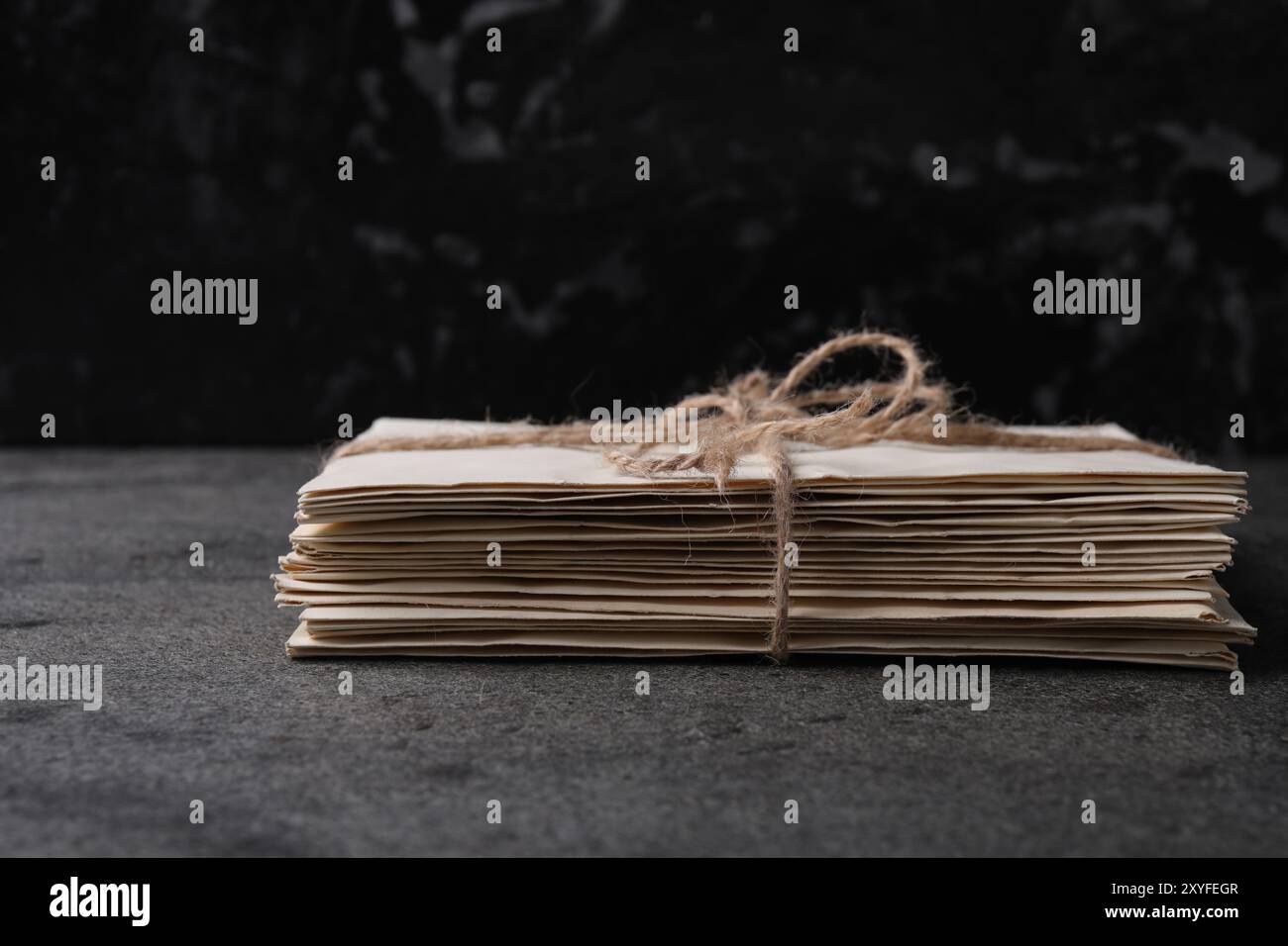 Stack of old letters tied with twine on grey table, closeup Stock Photo ...