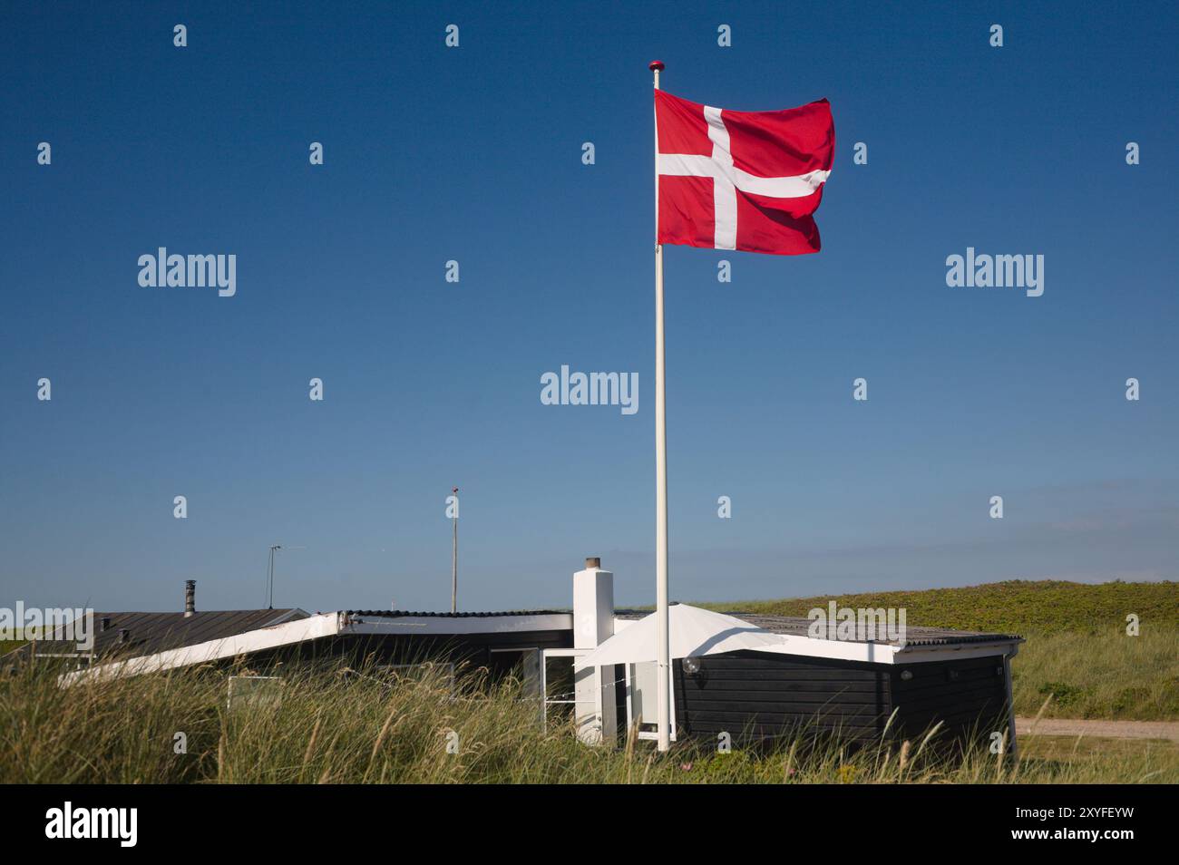 beach chalet with Danish flag flying at Fjand beach on North Sea West ...