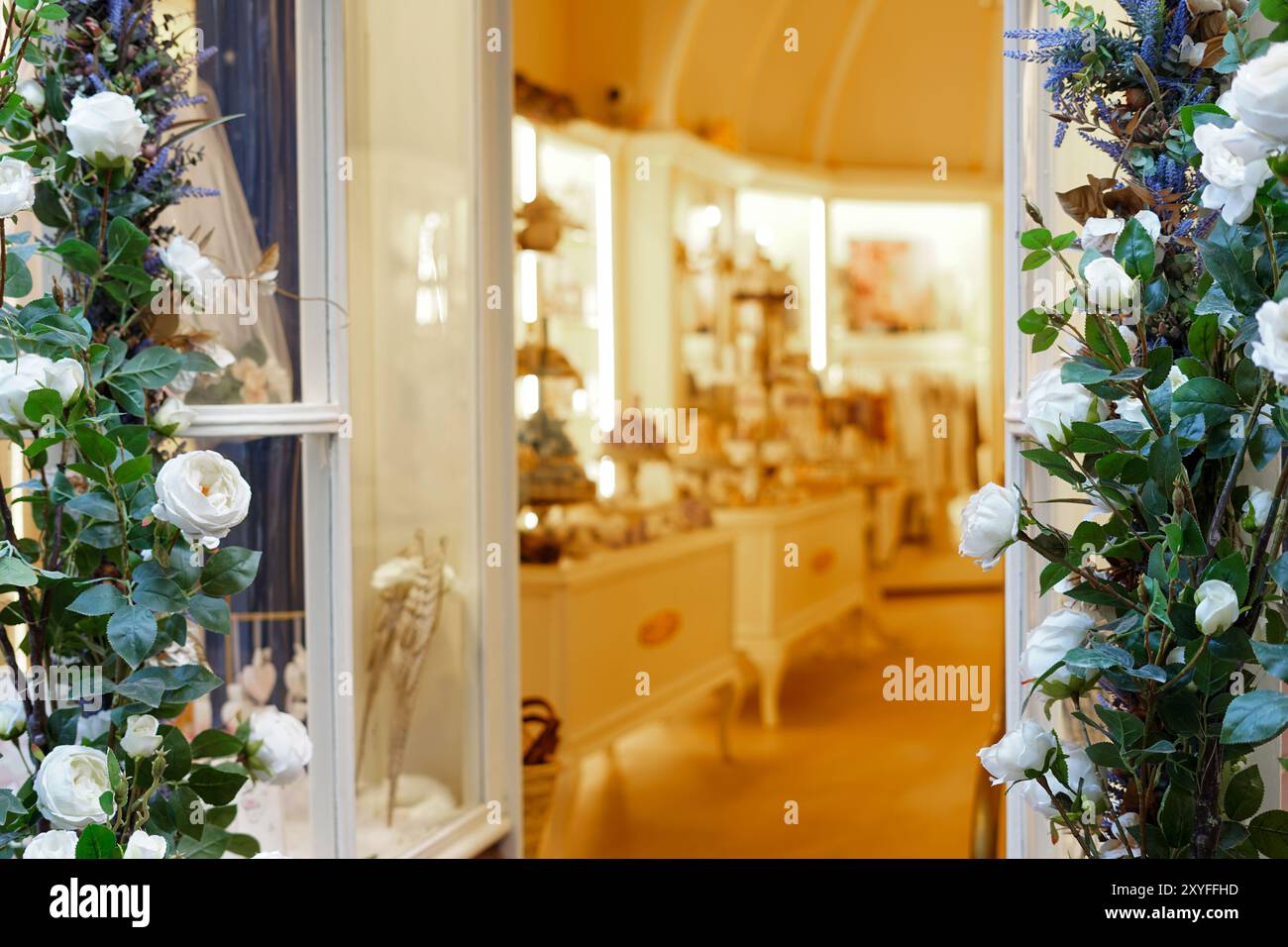 elegant interior of a boutique store decorated with white roses and ...
