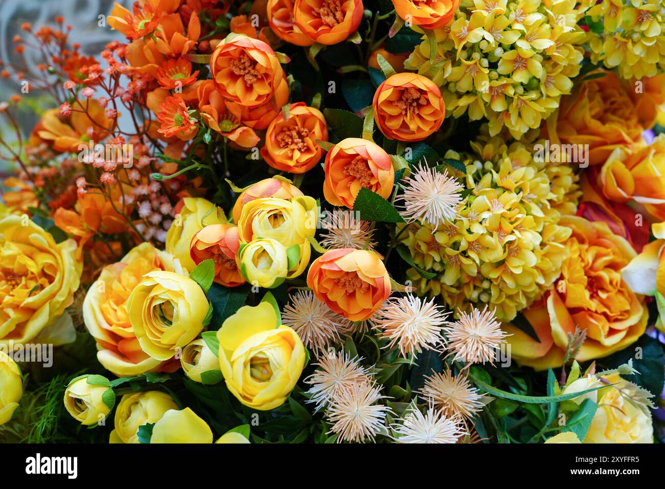 mix of orange and yellow flowers with various textures, showcasing a ...